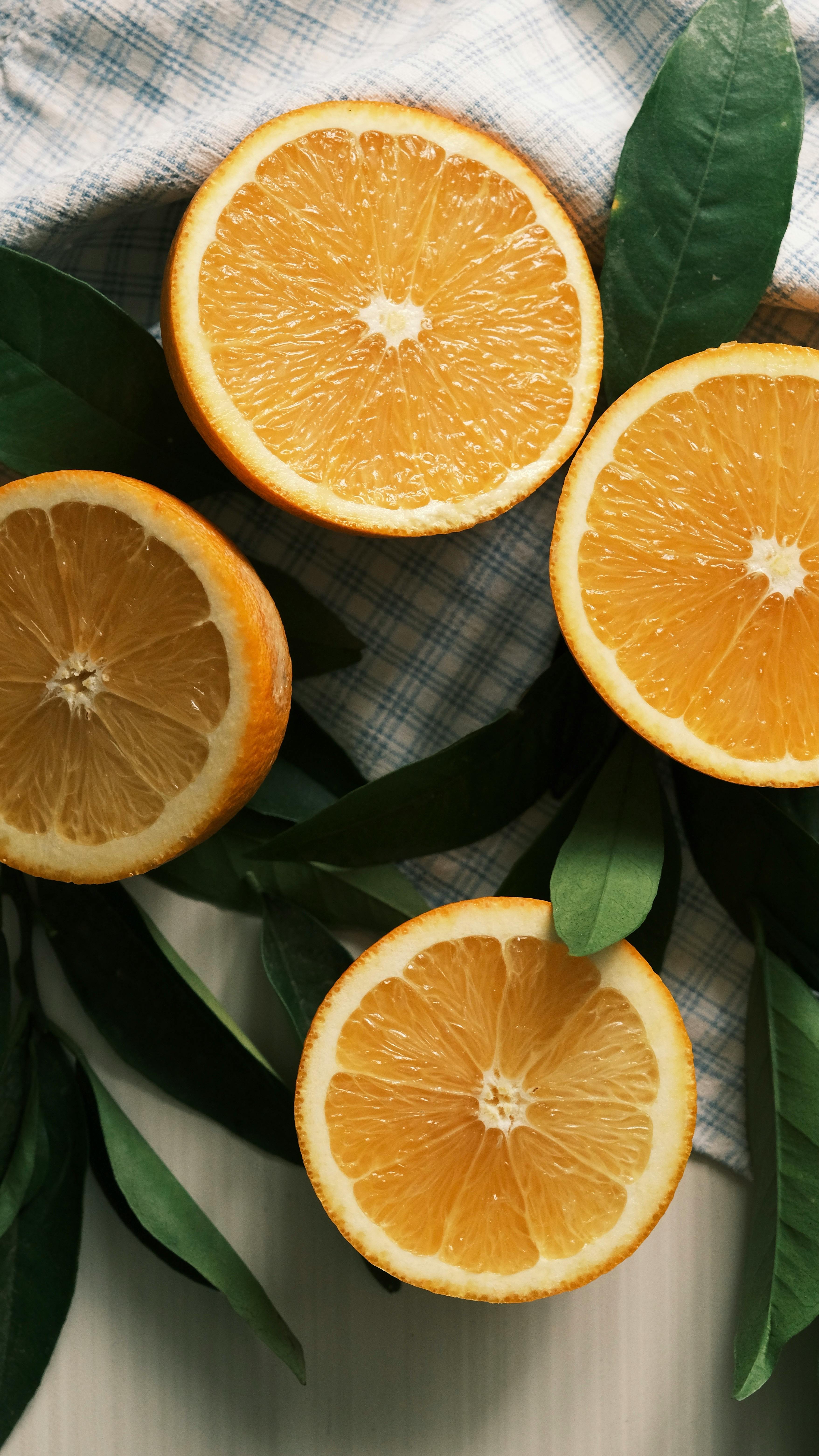 Fresh Sliced Oranges with Green Leaves · Free Stock Photo