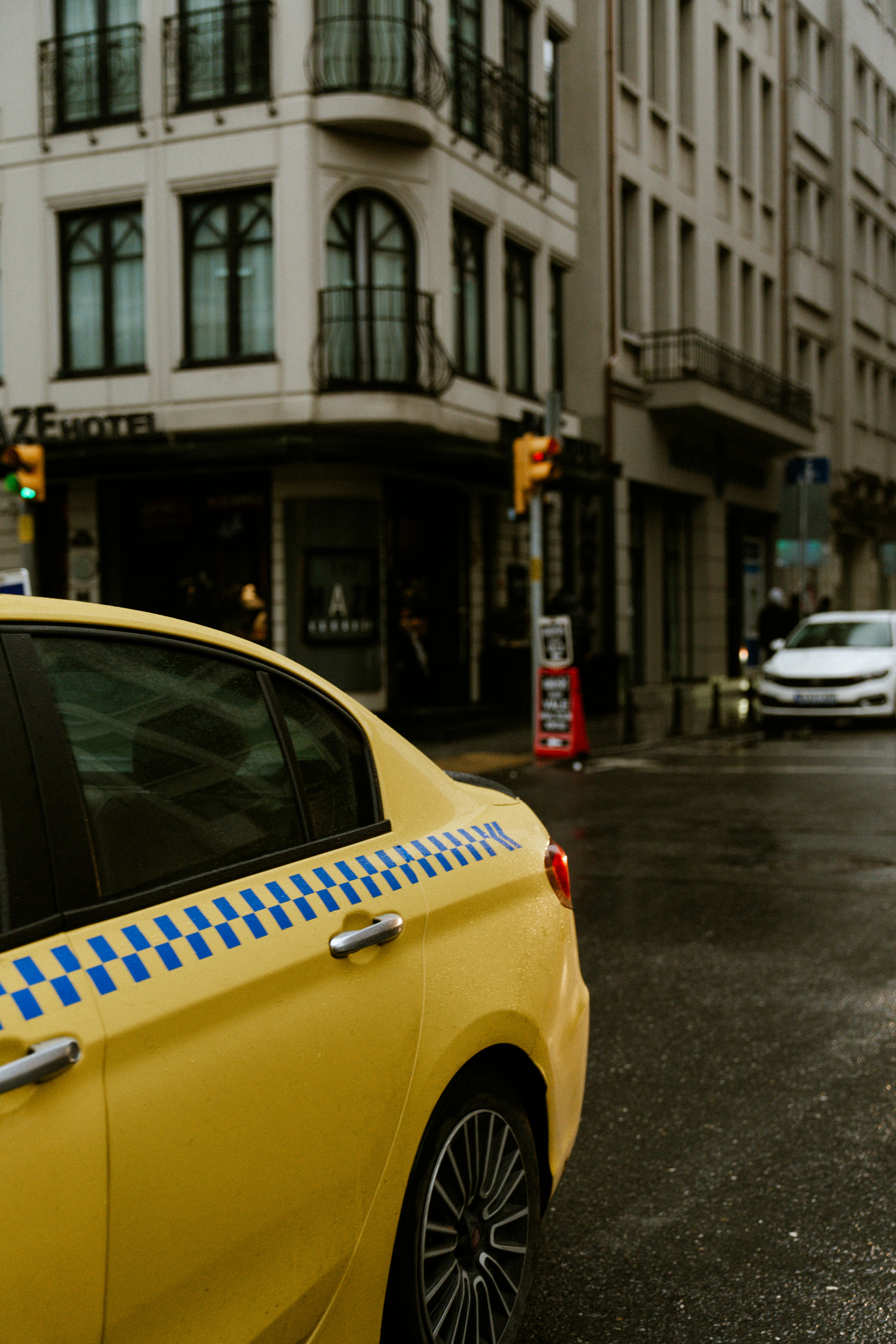 Urban Street Scene with Yellow Taxi Cab · Free Stock Photo