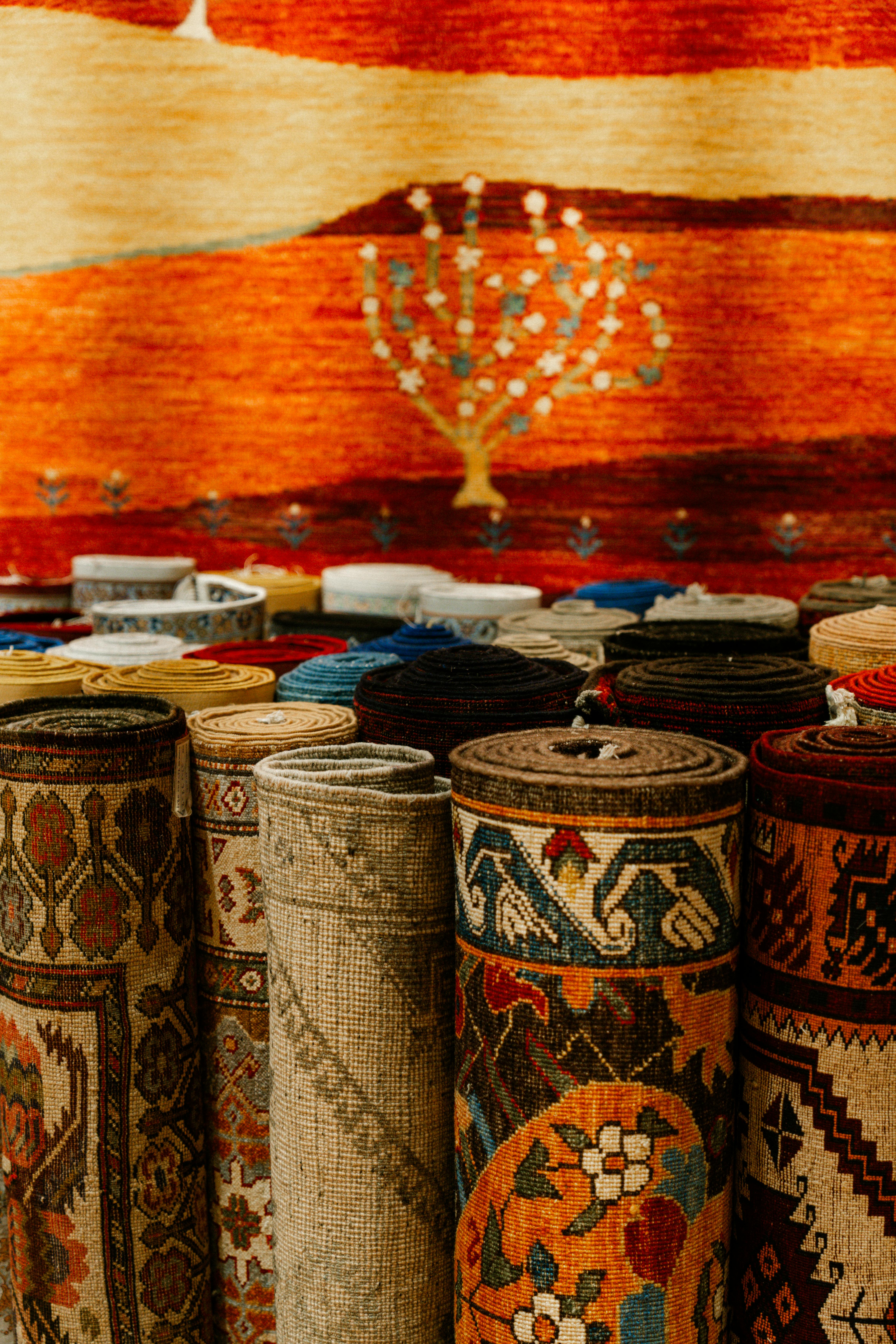 Colorful Rolled Rugs in Traditional Market · Free Stock Photo