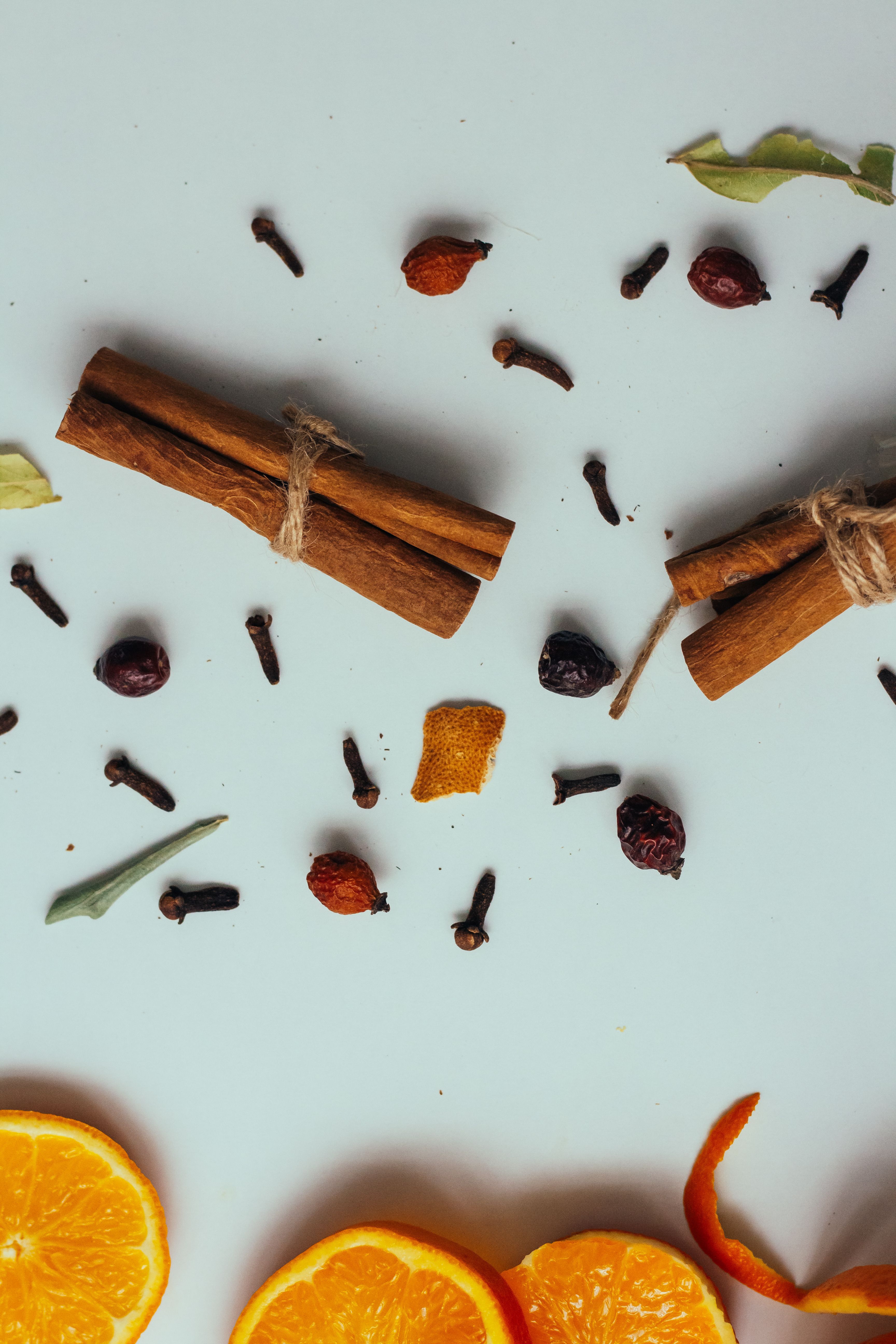 Culinary Spices and Orange Slices on White Background · Free Stock Photo
