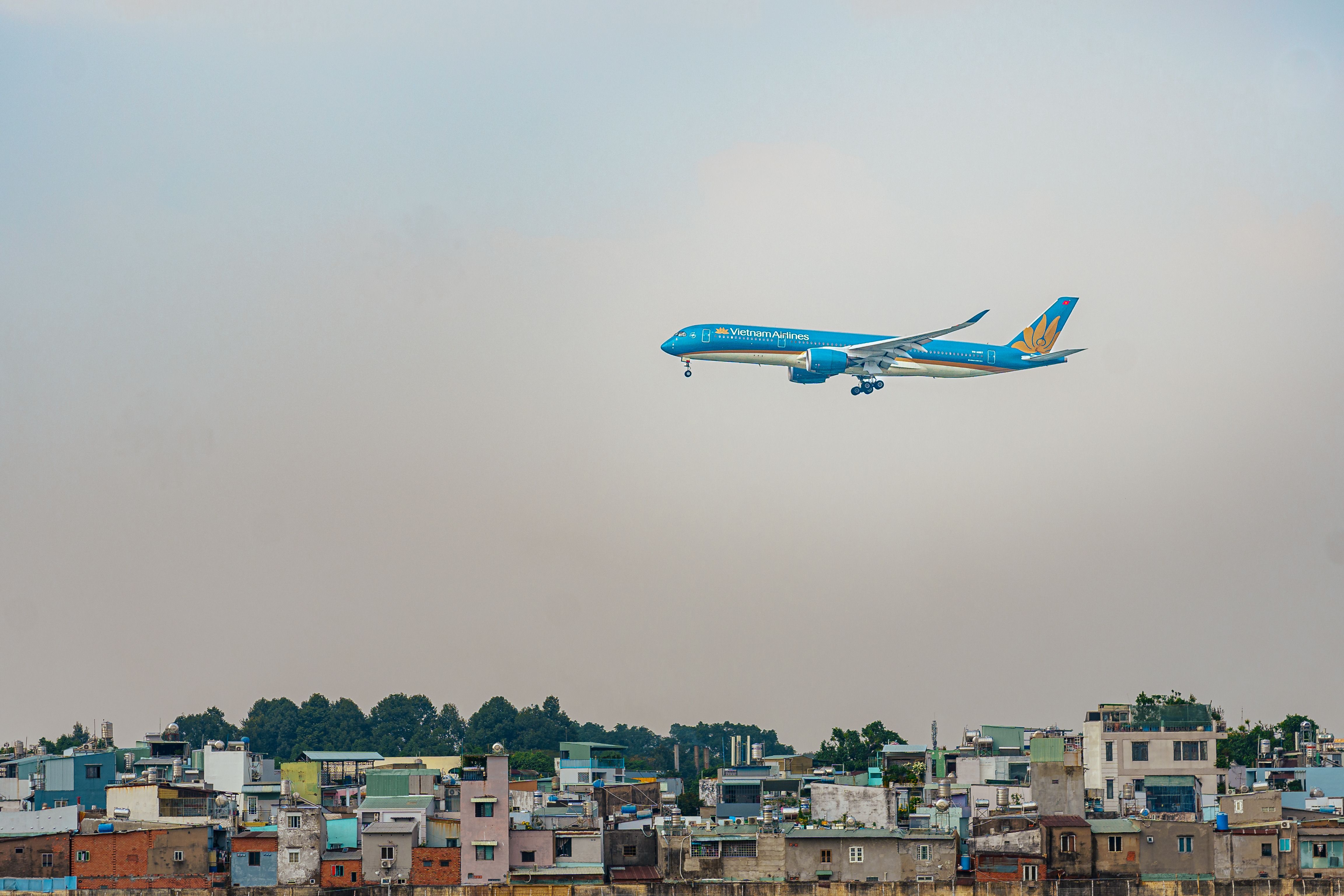 Airplane Flying Over Urban Residential Area · Free Stock Photo