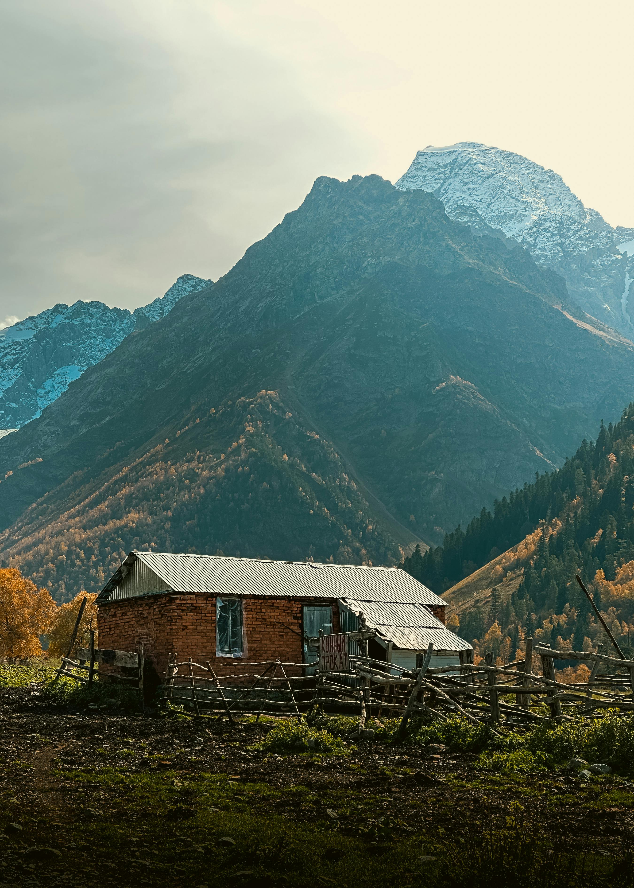 Rustic Cabin in Mountainous Autumn Landscape · Free Stock Photo