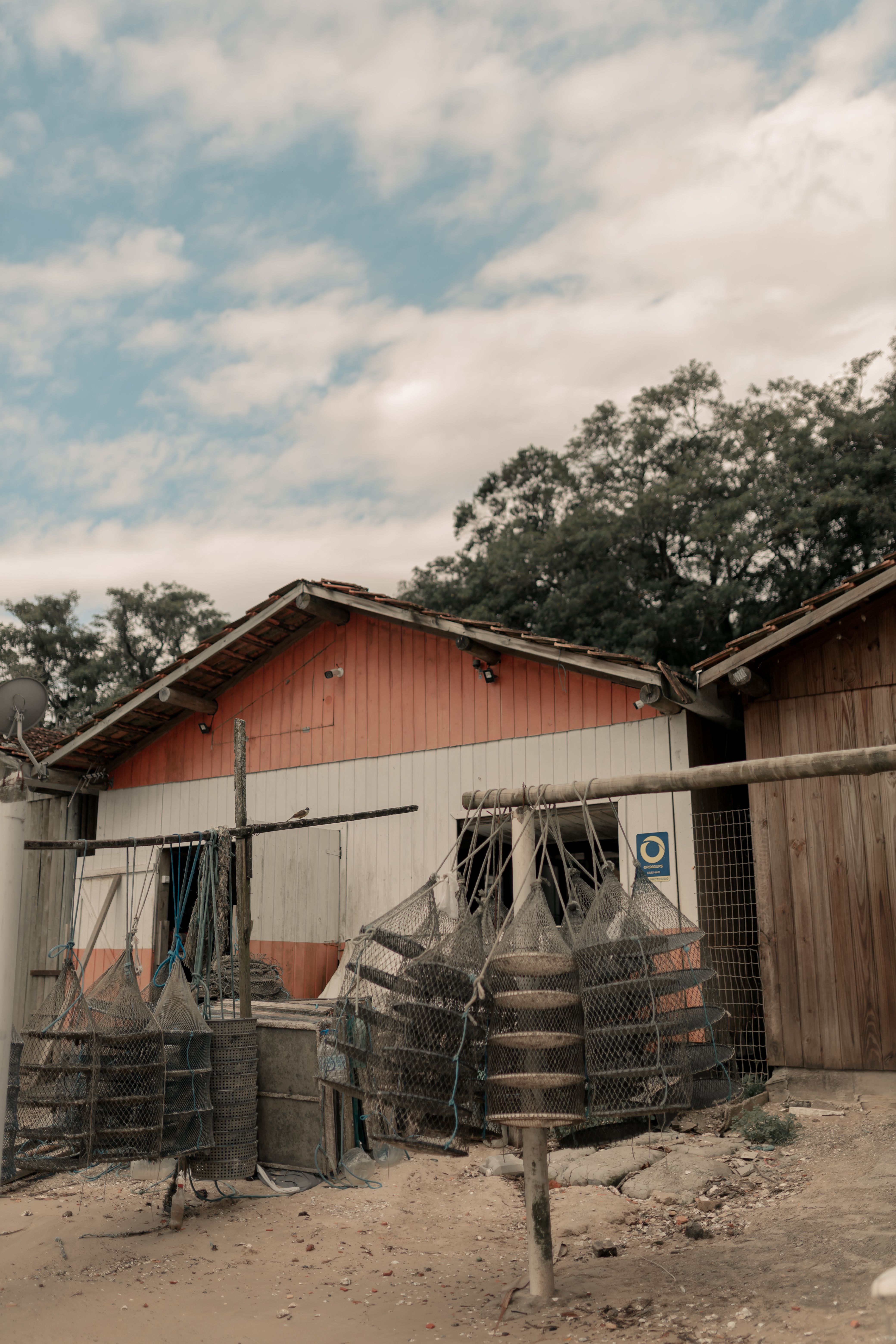 Rustic Rural Farm Buildings Under Cloudy Sky · Free Stock Photo
