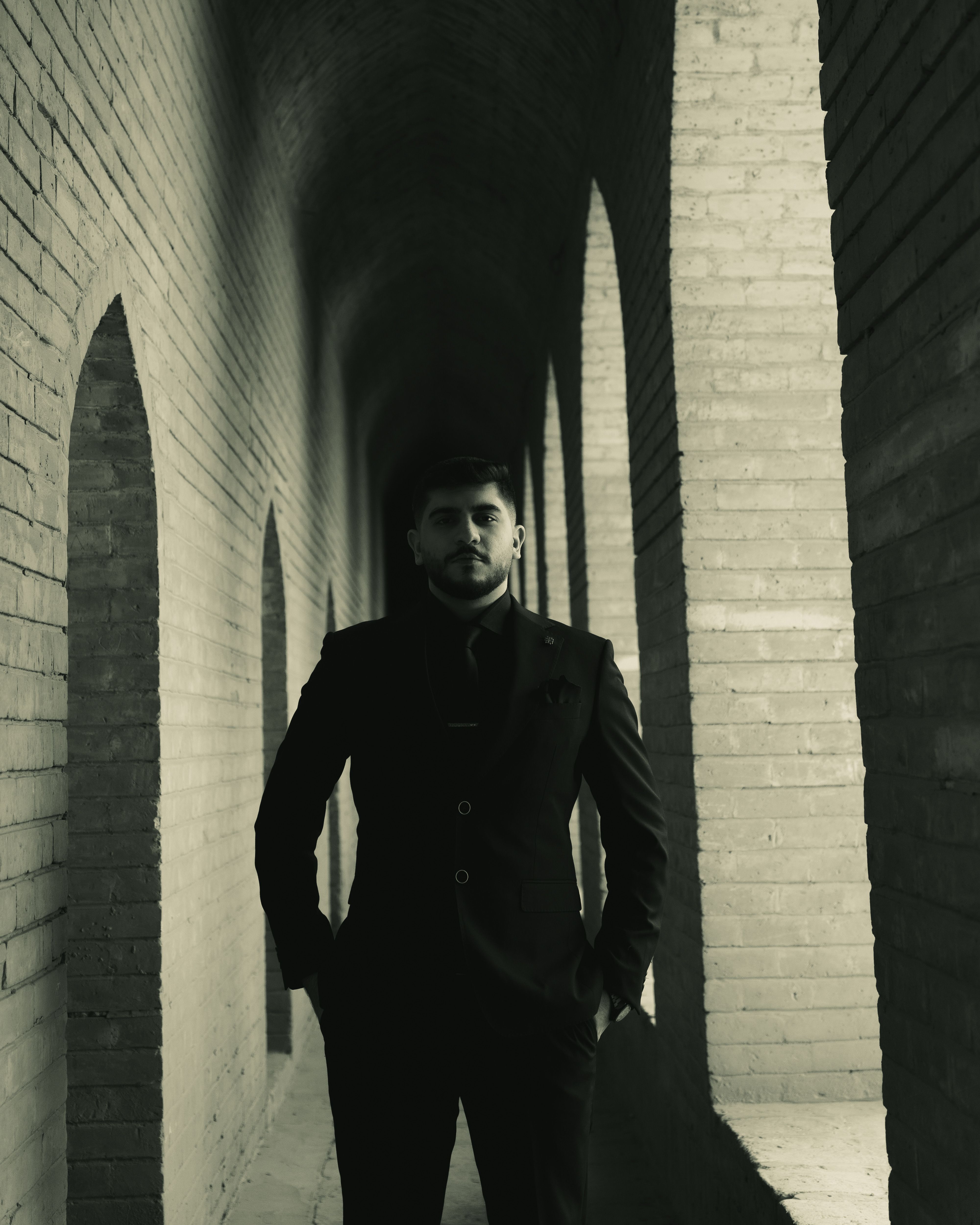 Moody Portrait of Man in Architectural Corridor · Free Stock Photo