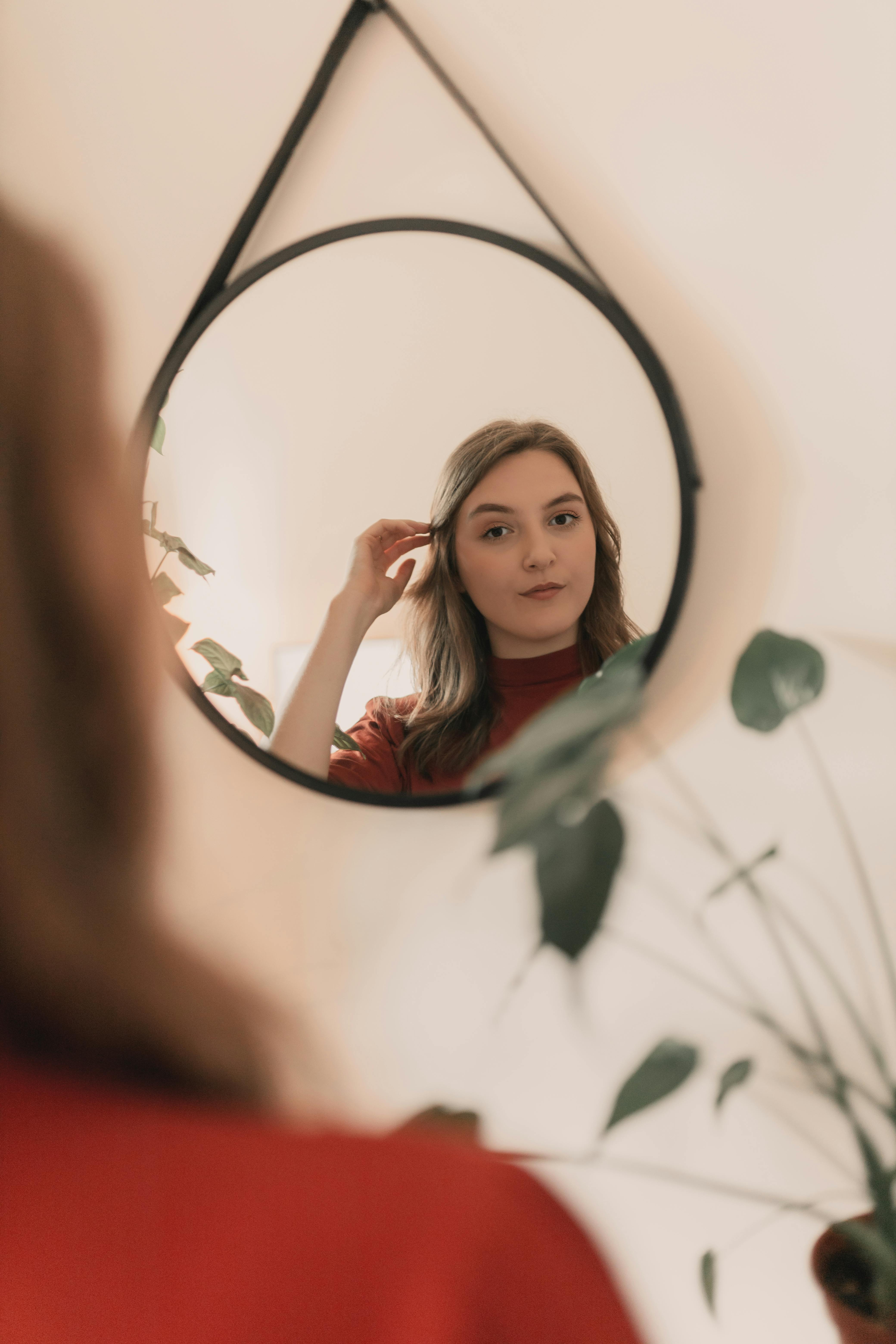 Woman Gazing at Mirror Reflection Indoors · Free Stock Photo