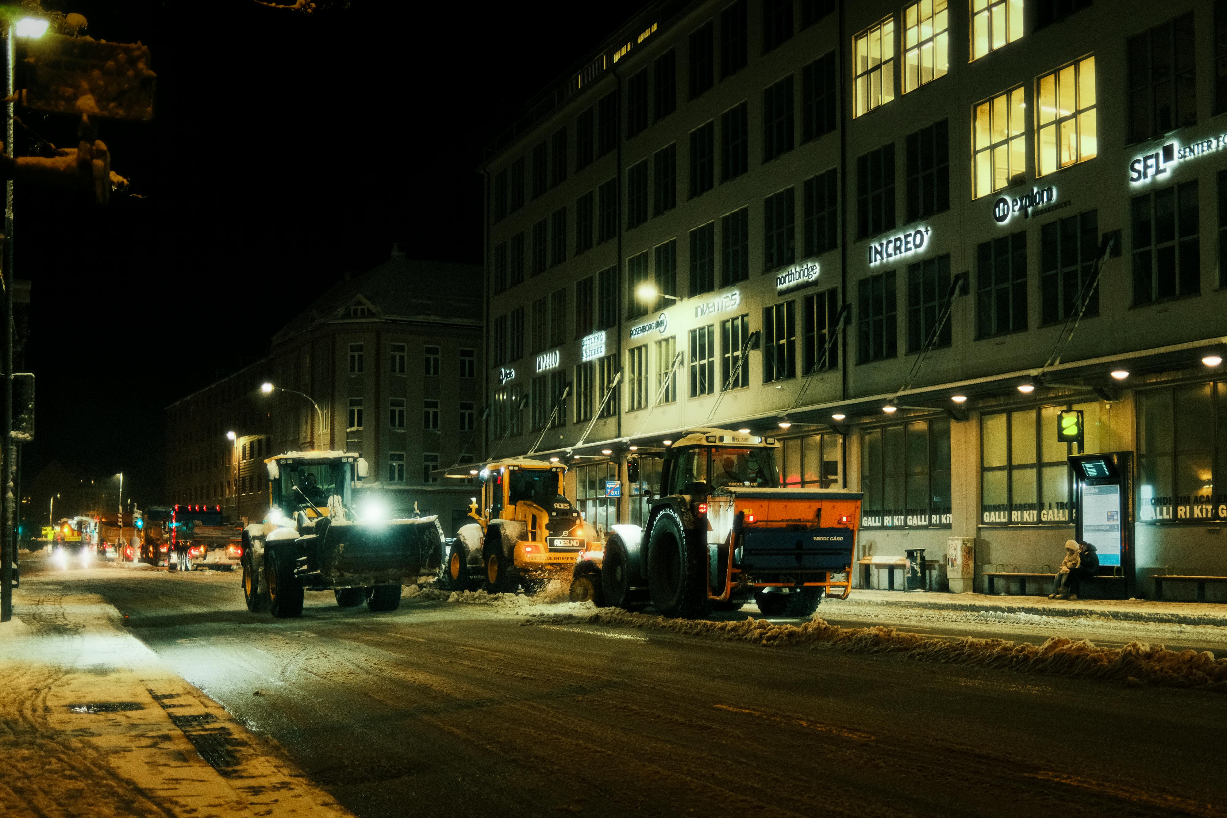 Nighttime Urban Snow Plowing Scene on City Street · Free Stock Photo
