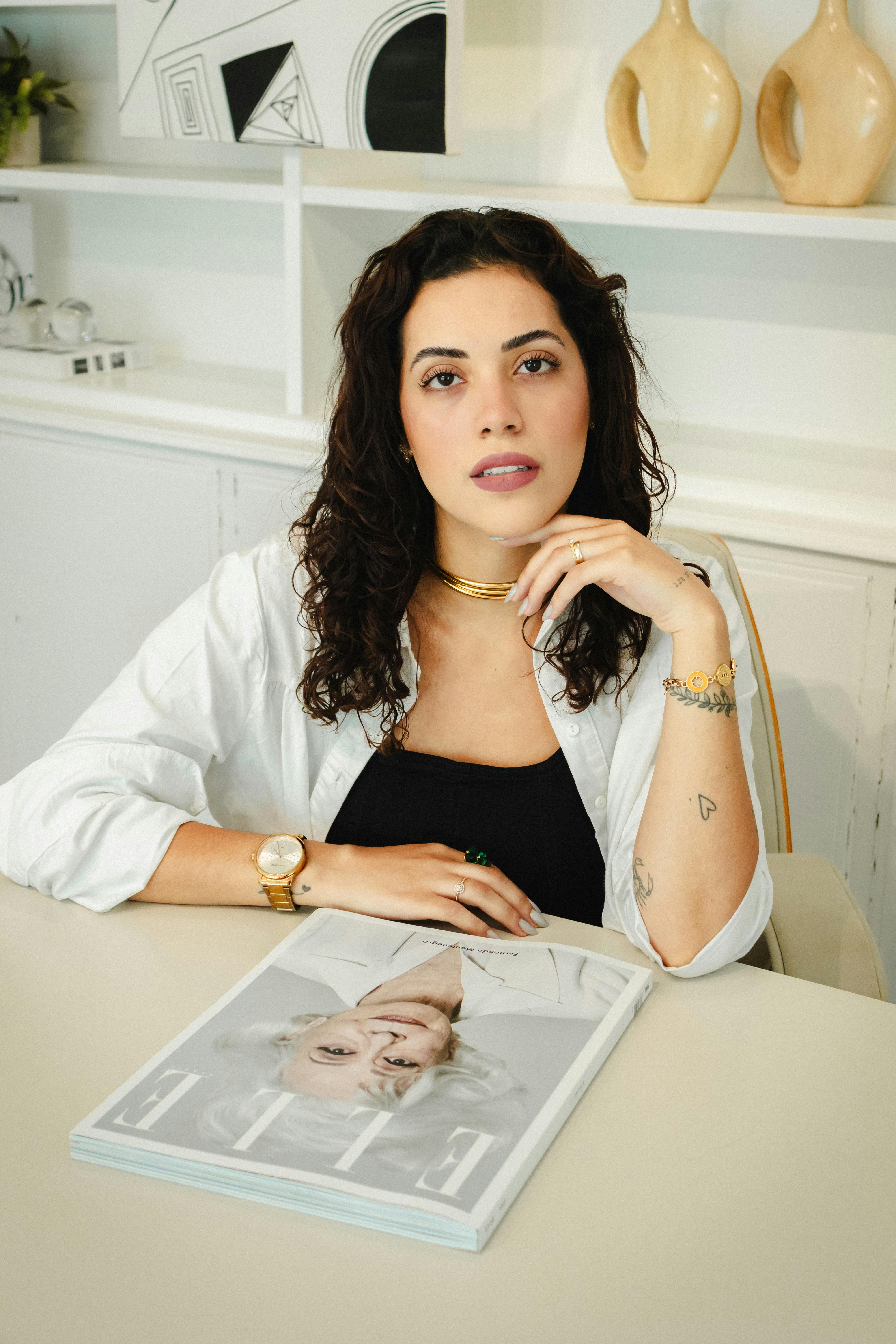 Woman Posing with Fashion Magazine in Modern Office · Free Stock Photo