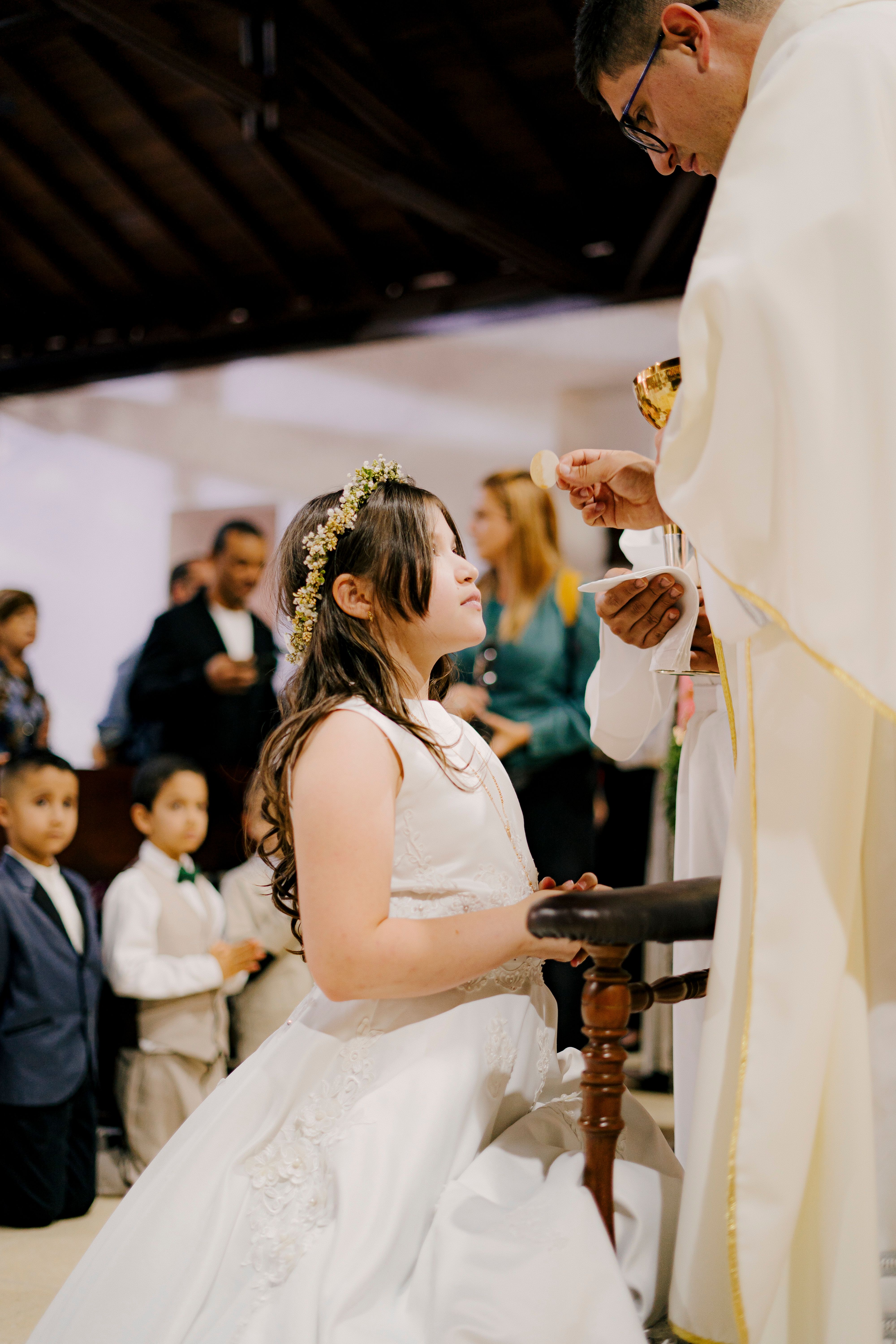 Young Girl Receiving First Communion in Church Ceremony · Free Stock Photo