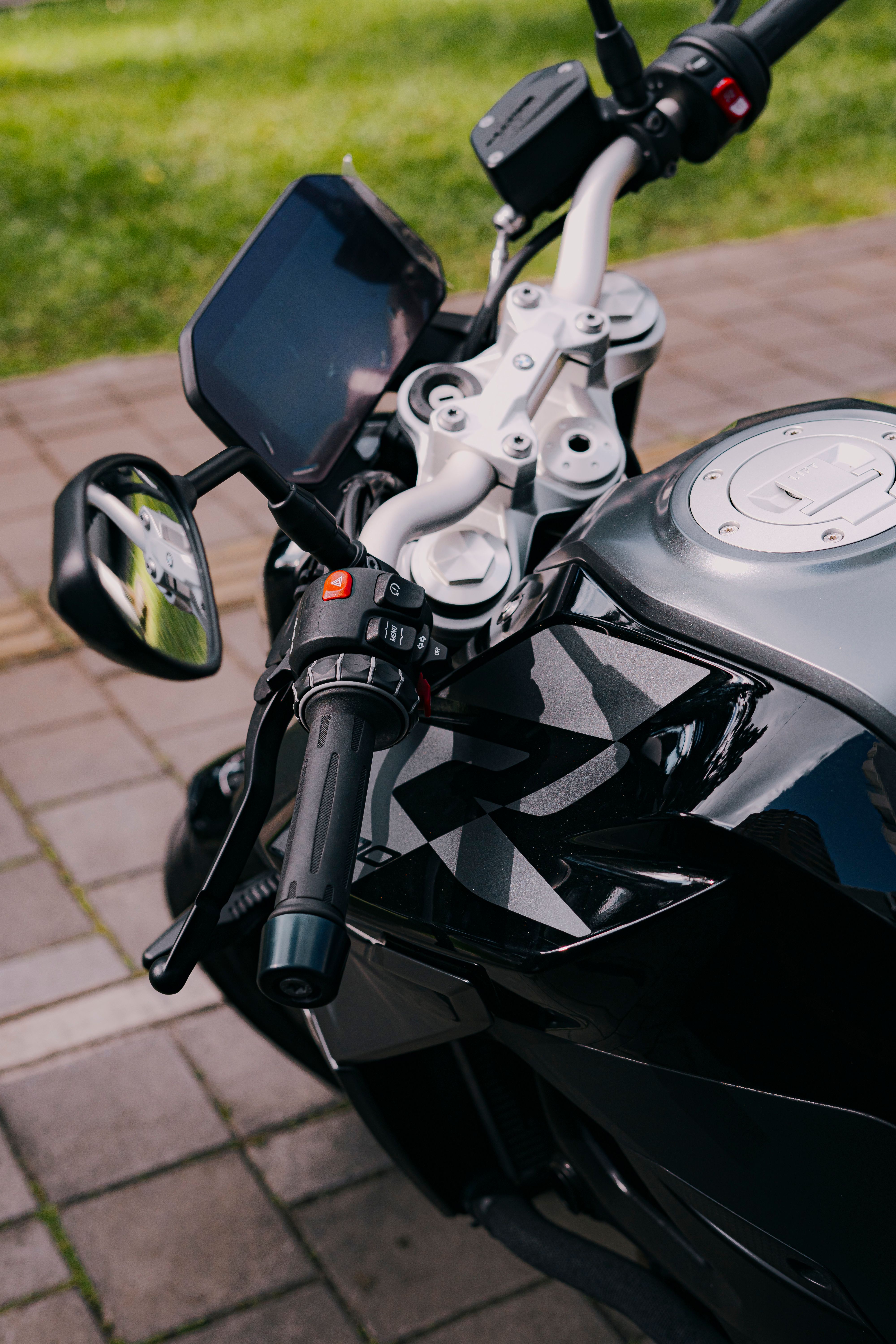 Glossy Black Motorcycle on Pavement Outdoors · Free Stock Photo