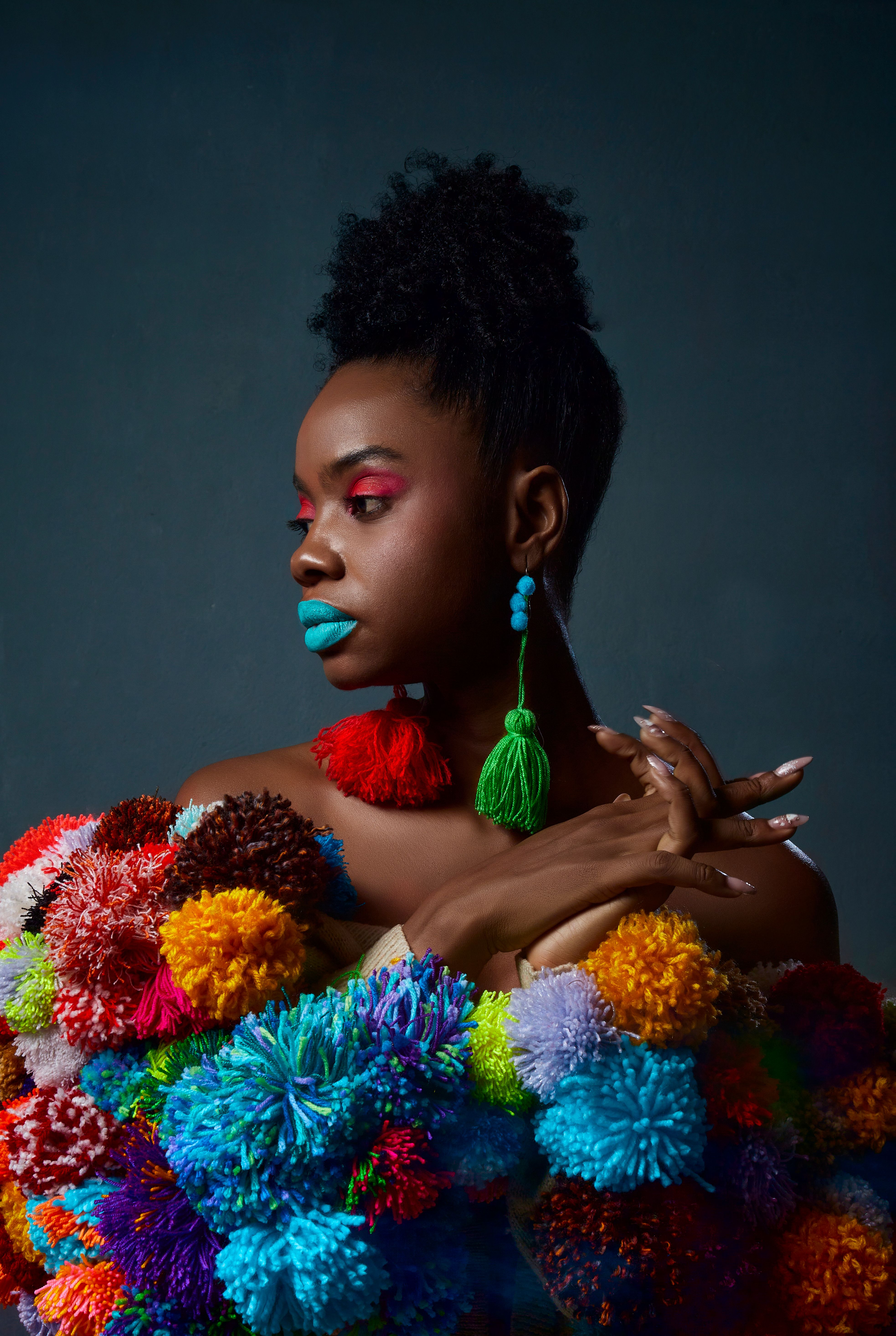 Vibrant Fashion Portrait of Woman with Colorful Textiles · Free Stock Photo