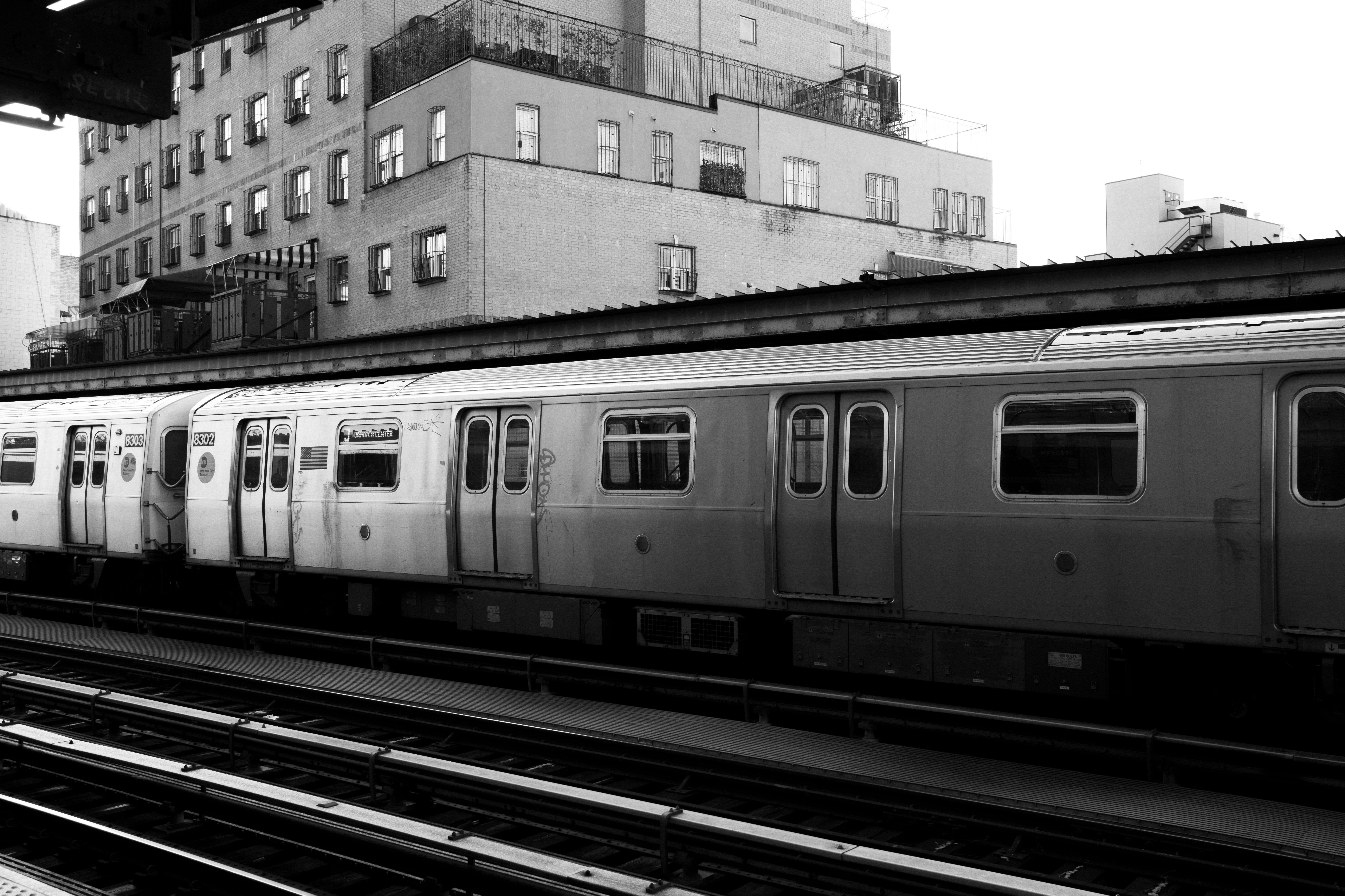 Urban Subway Train Passing Urban Buildings · Free Stock Photo