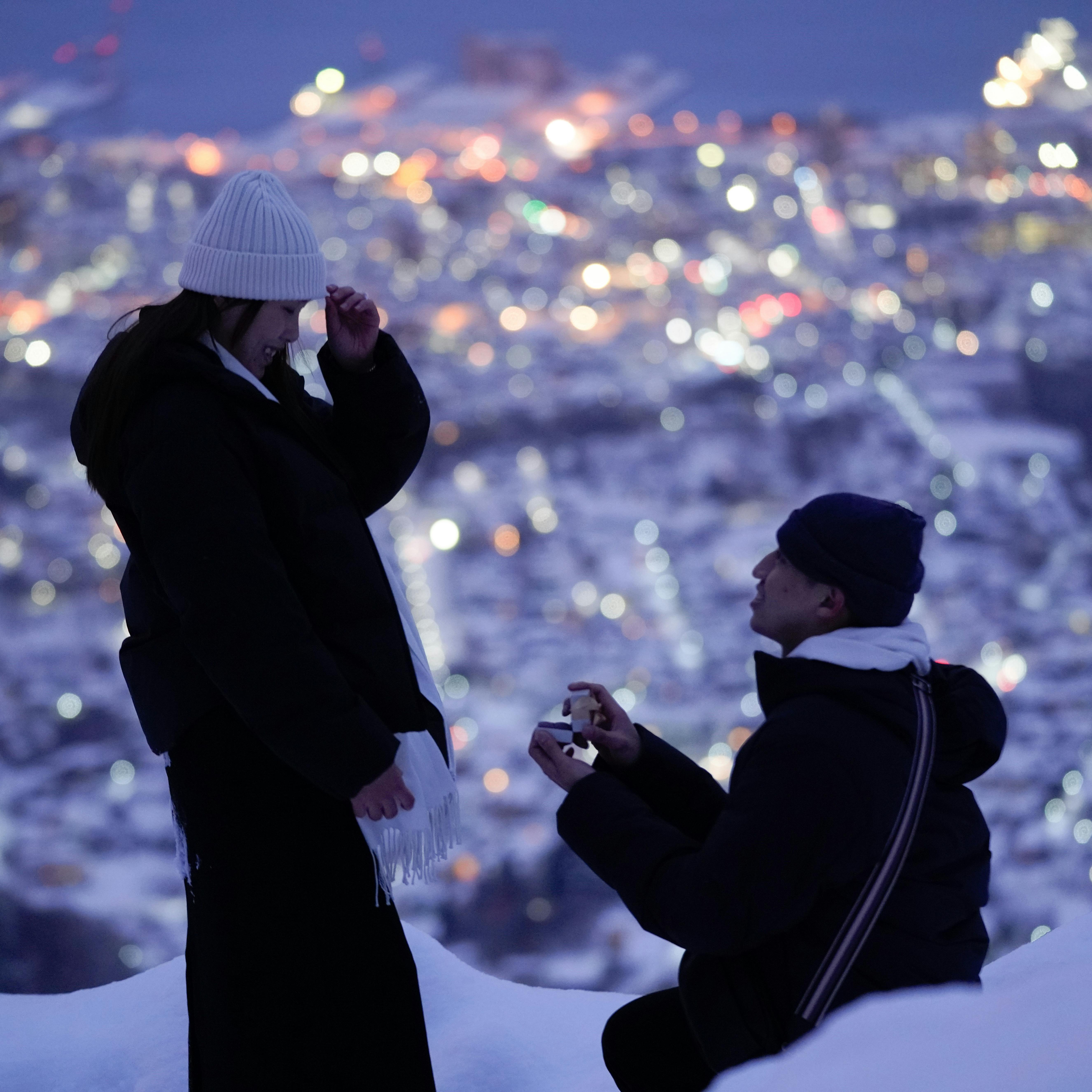 Romantic Winter Proposal Overlooking City Lights · Free Stock Photo