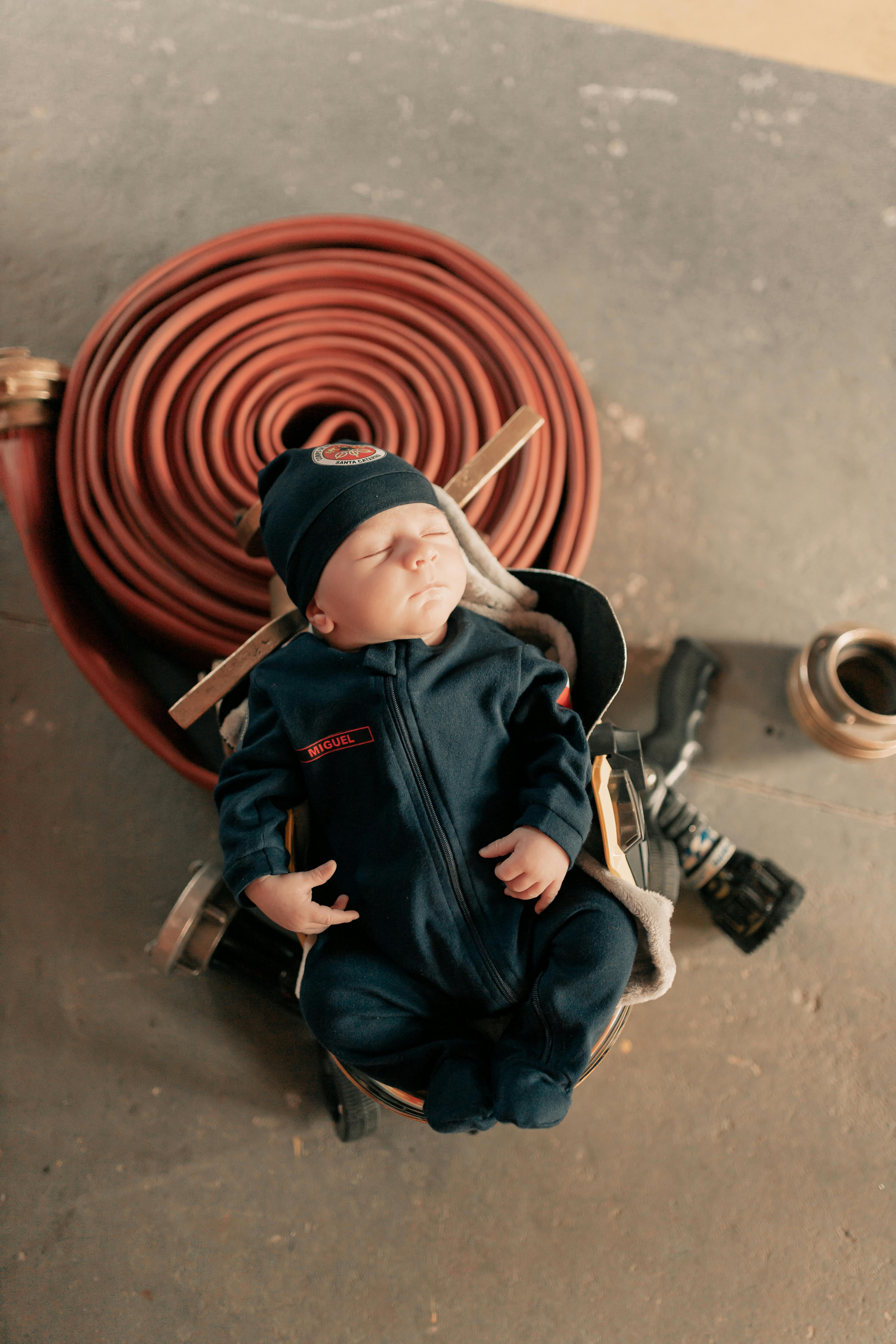 Sleeping Baby Dressed as Firefighter · Free Stock Photo