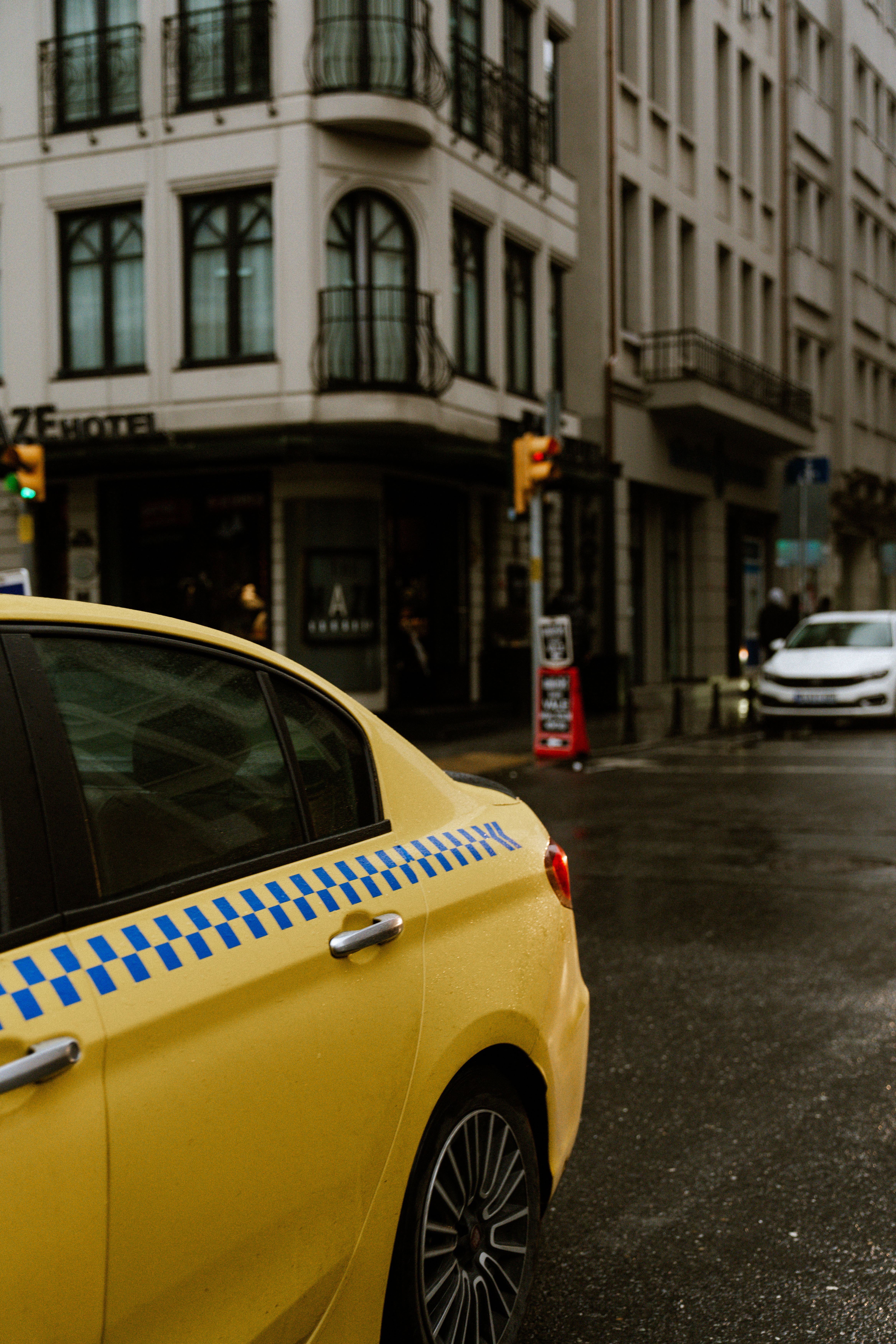 Urban Taxis on a Rainy City Street Corner · Free Stock Photo