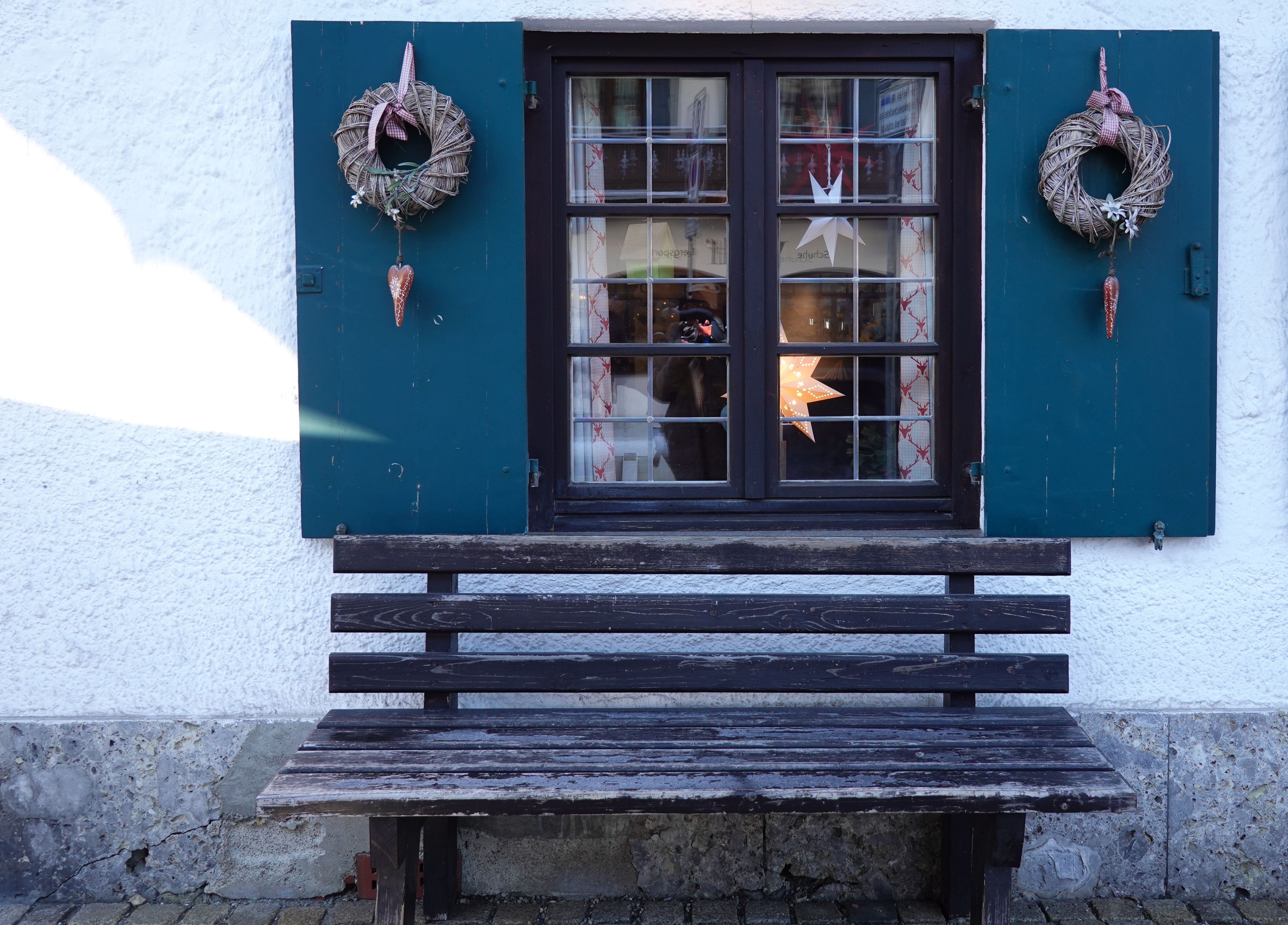 Charming Rustic Window with Wreaths and Bench · Free Stock Photo