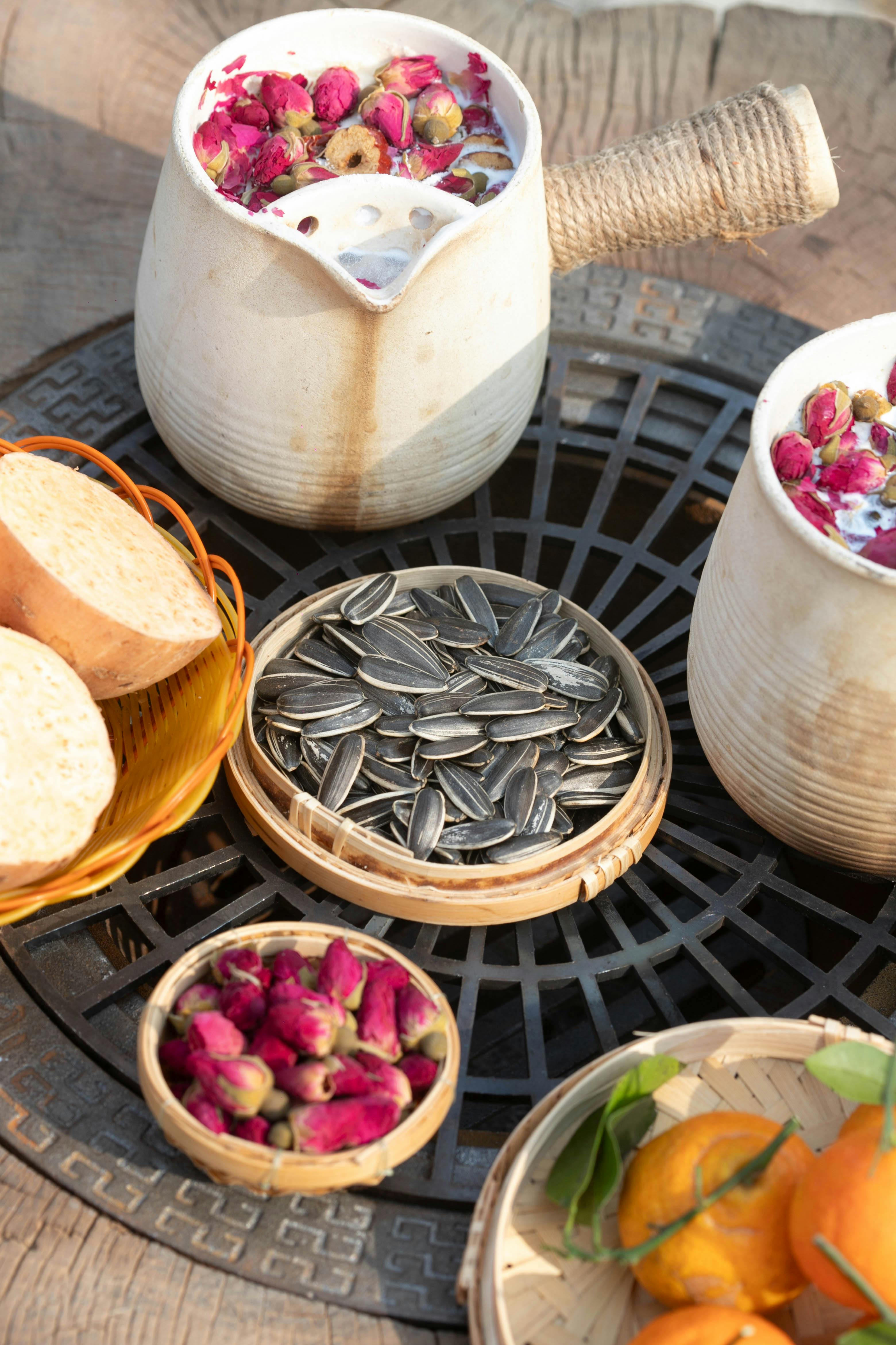 Rustic Tea Set with Rose Petals and Sunflower Seeds · Free Stock Photo