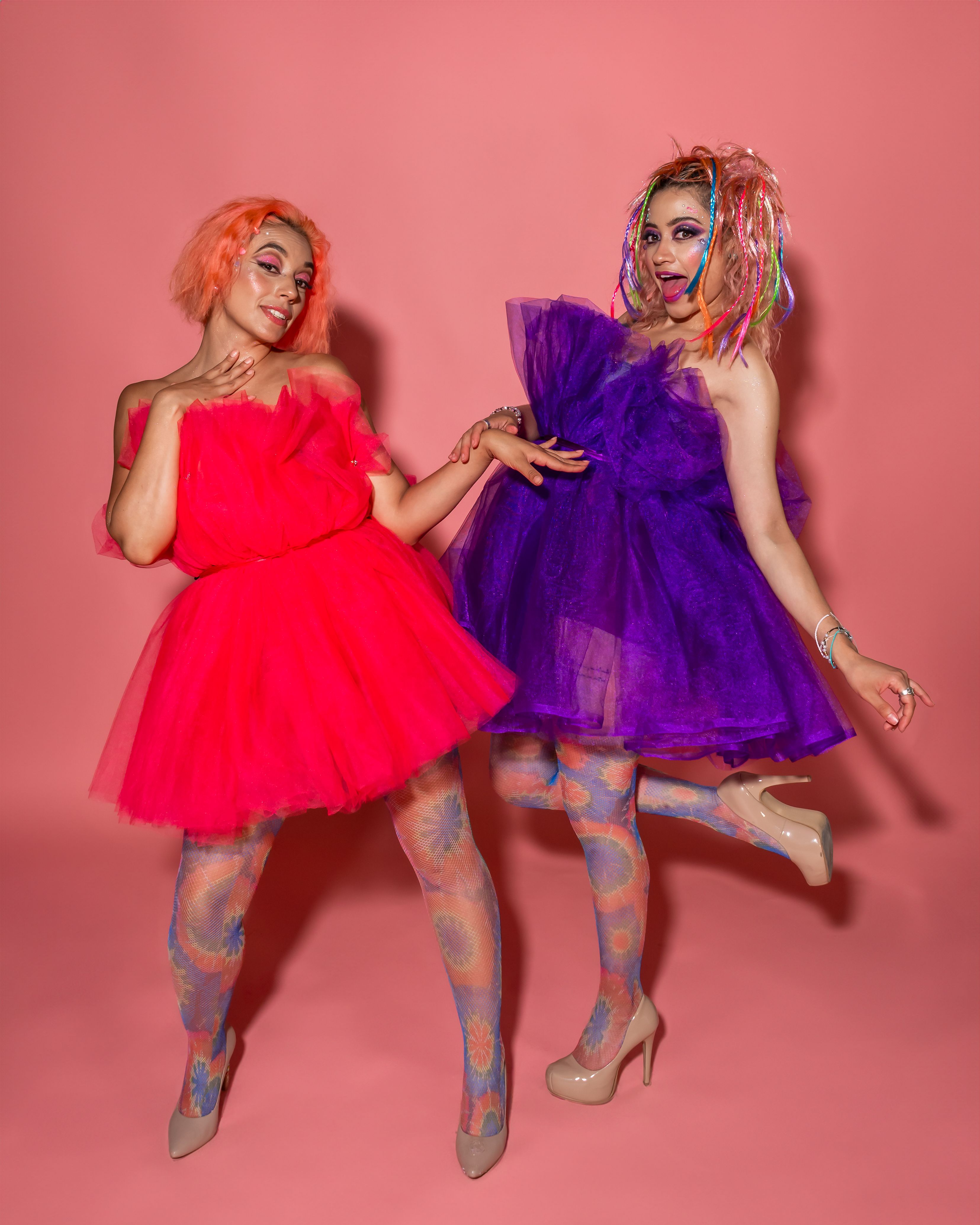 Colorful Fashion Duo in Vibrant Costumes · Free Stock Photo