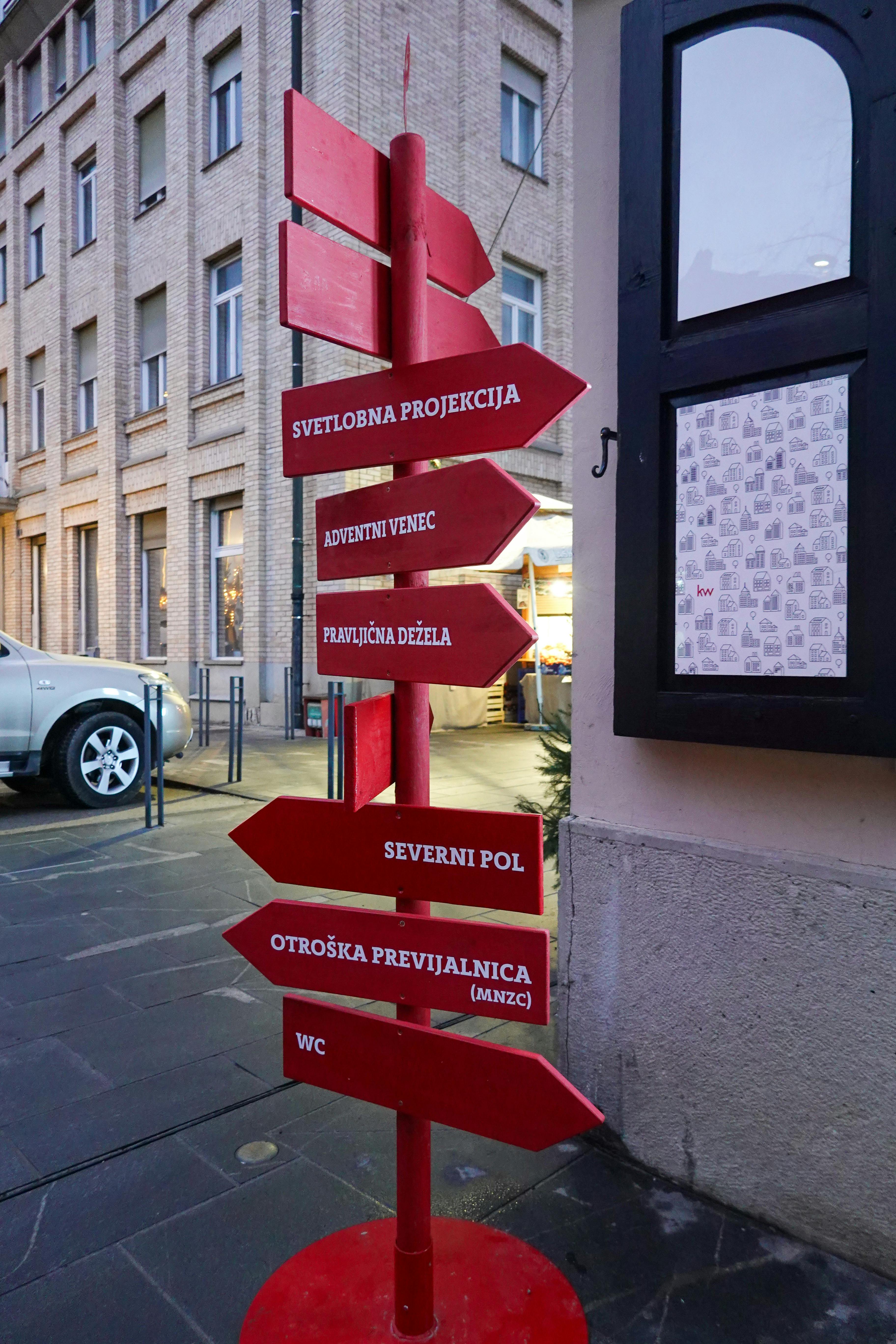 Red Directional Signpost in Urban Setting · Free Stock Photo