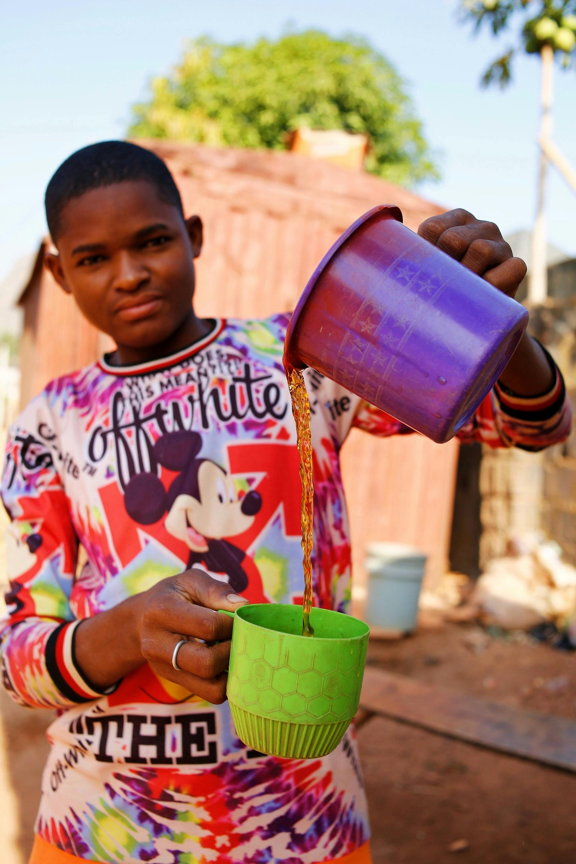 Young Man Pouring Tea in Abuja, Nigeria · Free Stock Photo