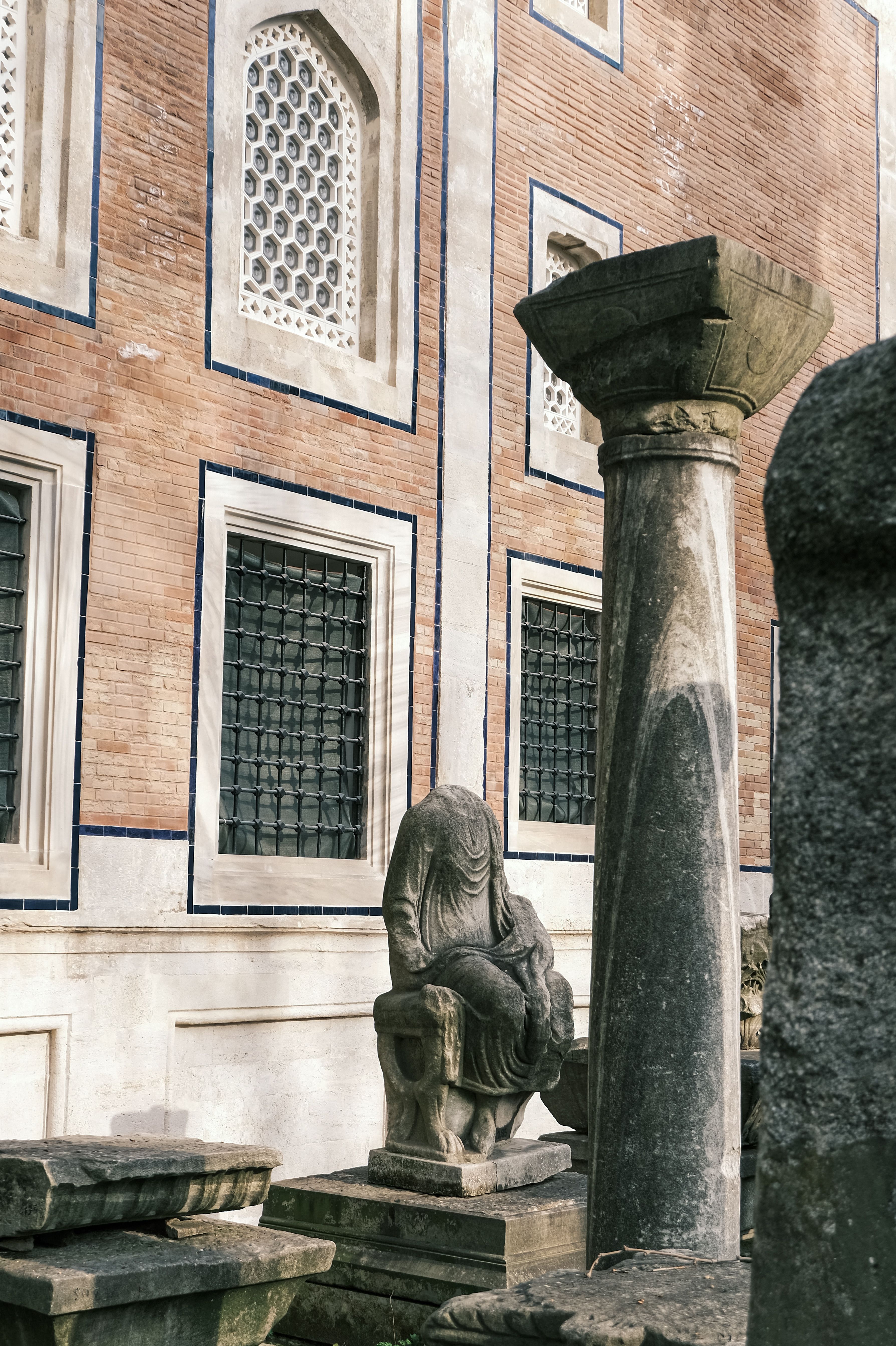 Ancient Artifacts Against Historical Brick Wall · Free Stock Photo