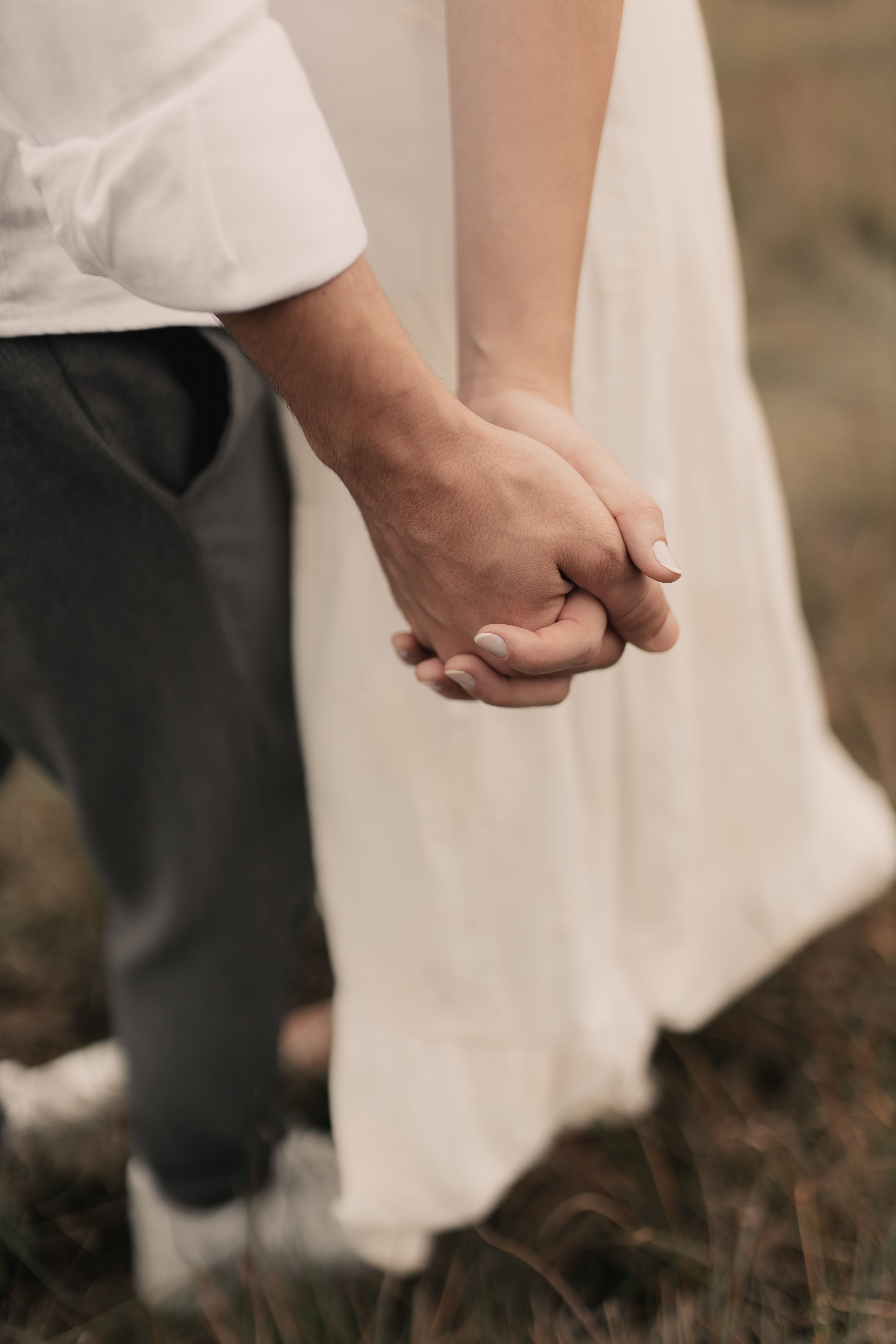 Romantic Couple Holding Hands Outdoors · Free Stock Photo