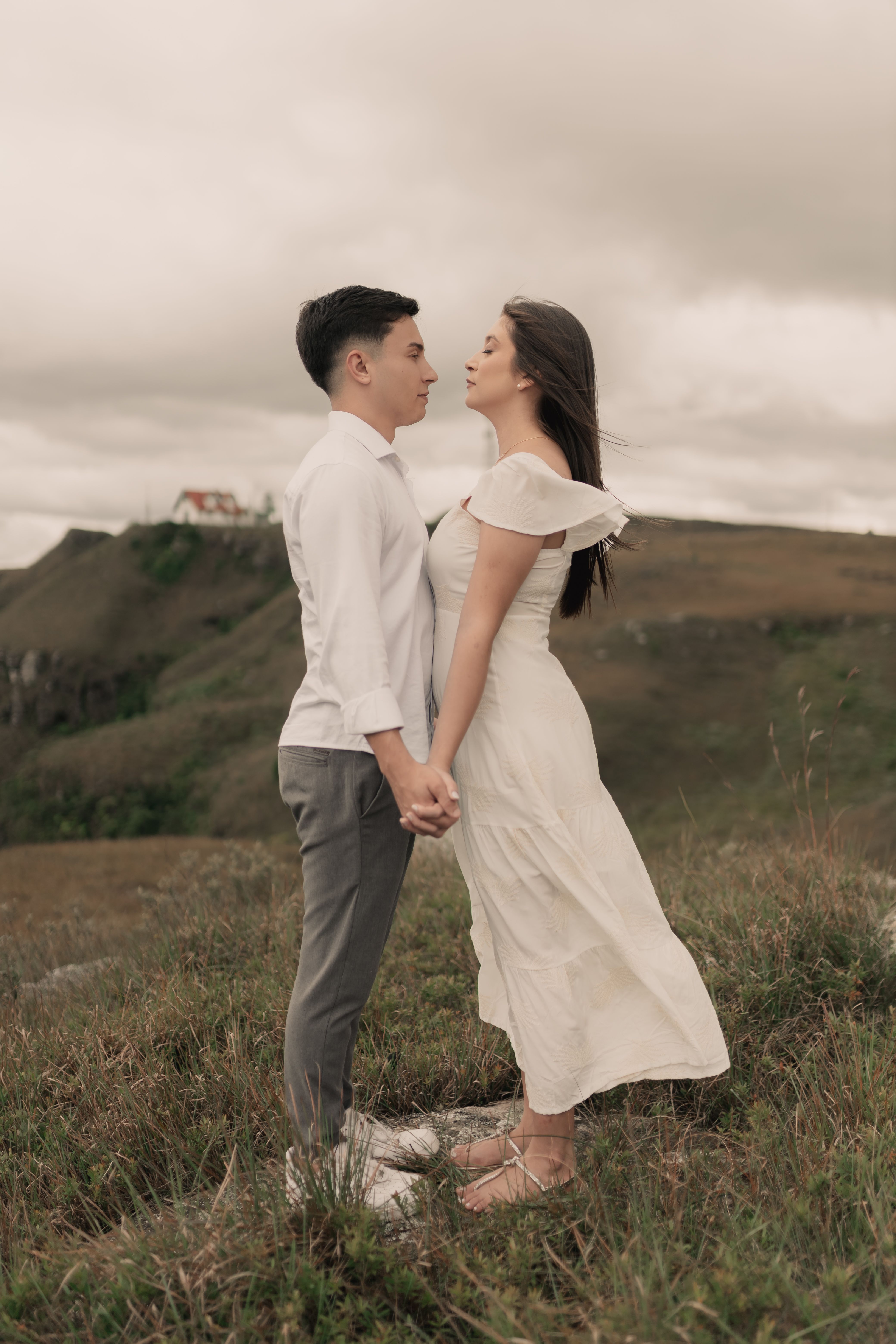 Romantic Couple Holding Hands in Open Field · Free Stock Photo