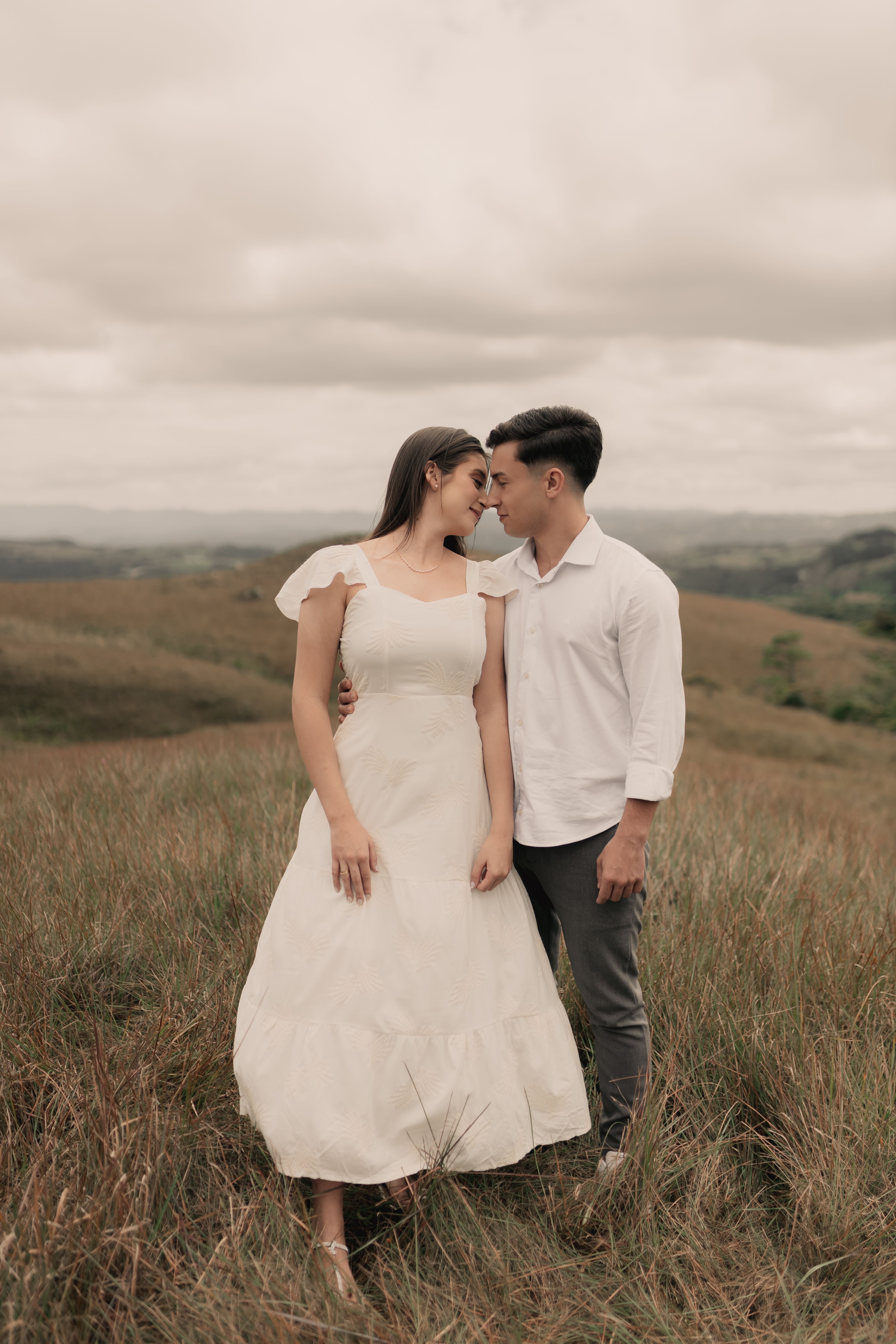 Romantic Couple Embracing in Open Field · Free Stock Photo