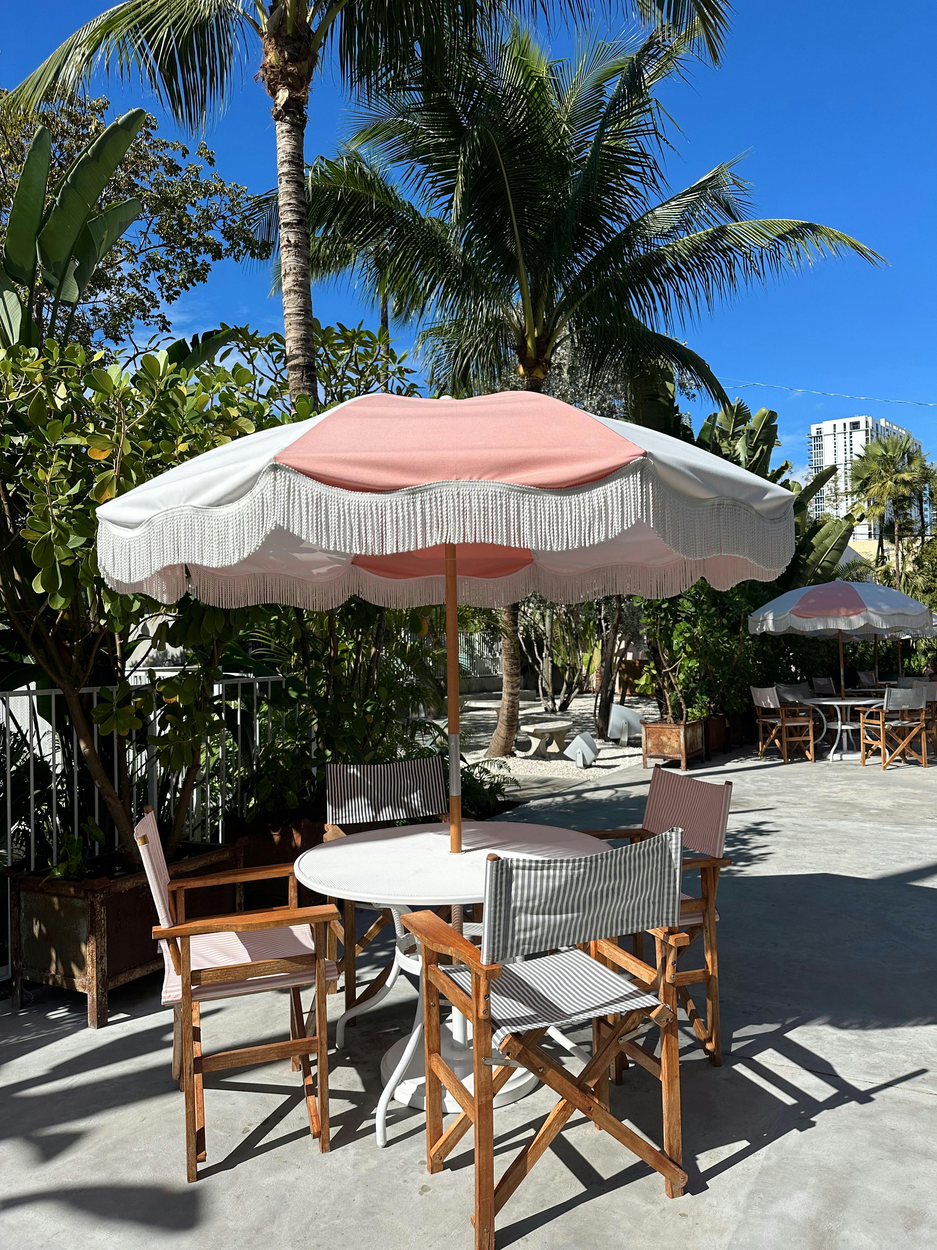 Tropical Outdoor Cafe Setting with Umbrella · Free Stock Photo
