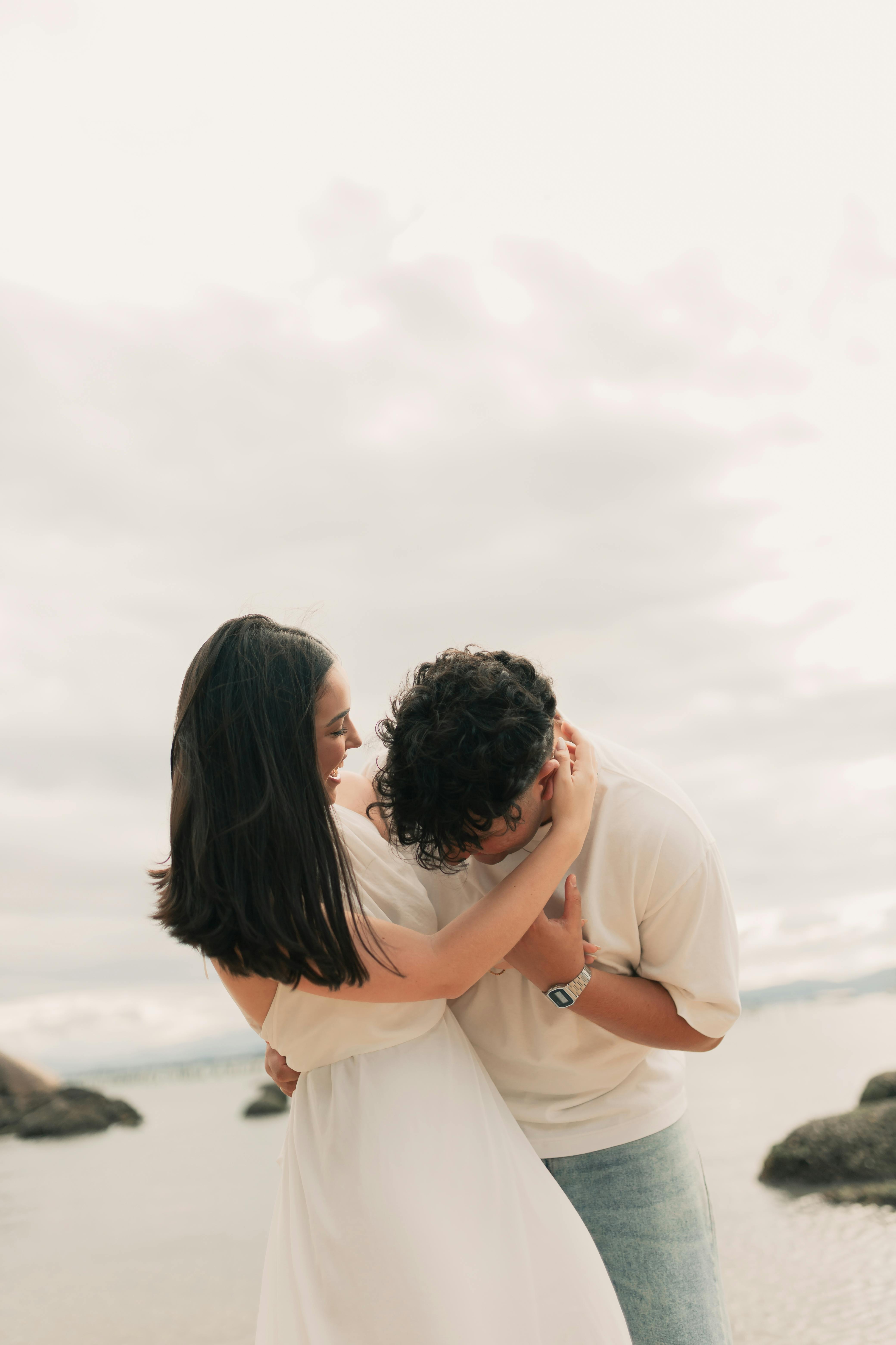 Romantic Couple Embracing by Seaside · Free Stock Photo