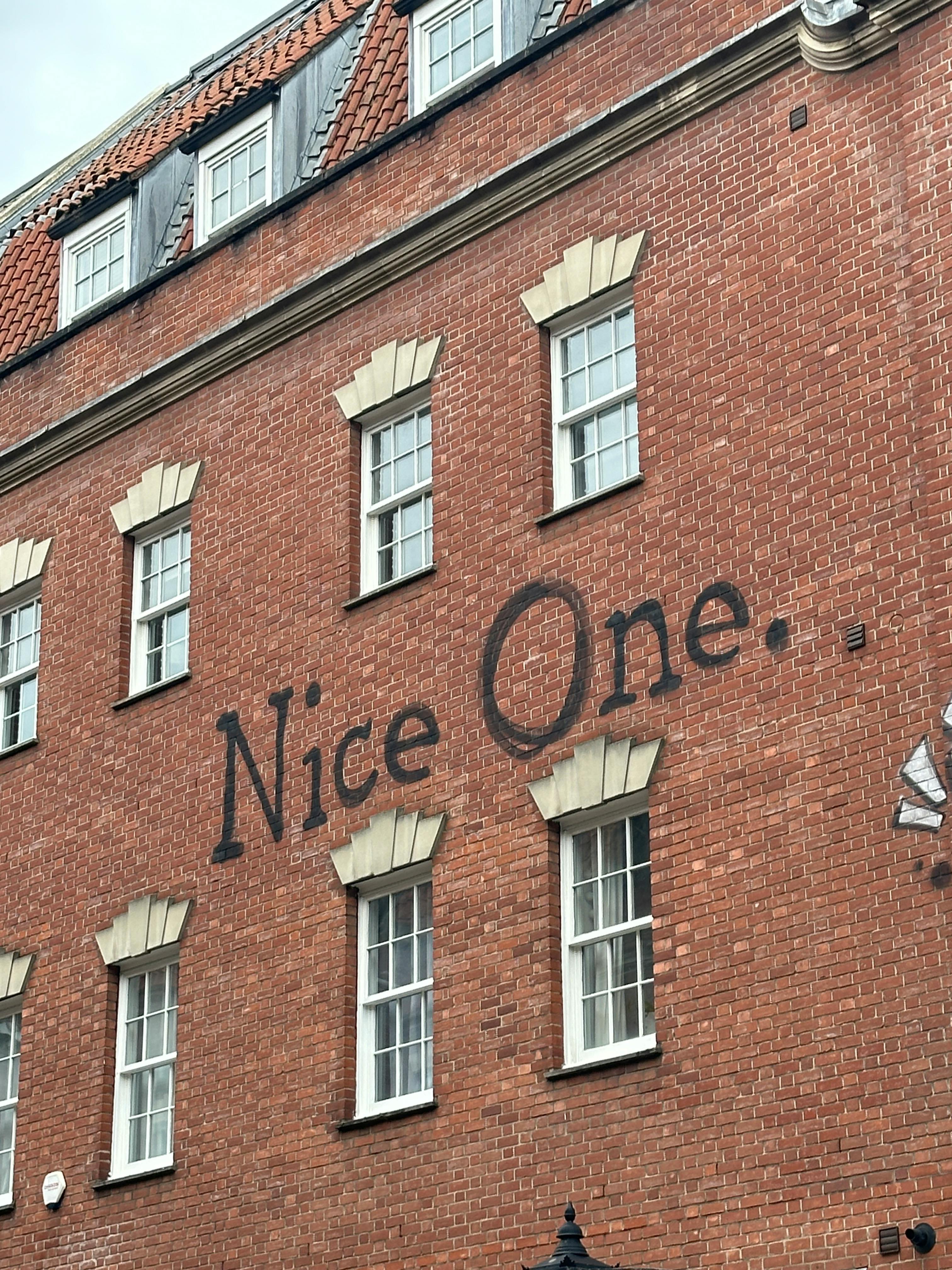 Historic Brick Building with Inspiring Text · Free Stock Photo