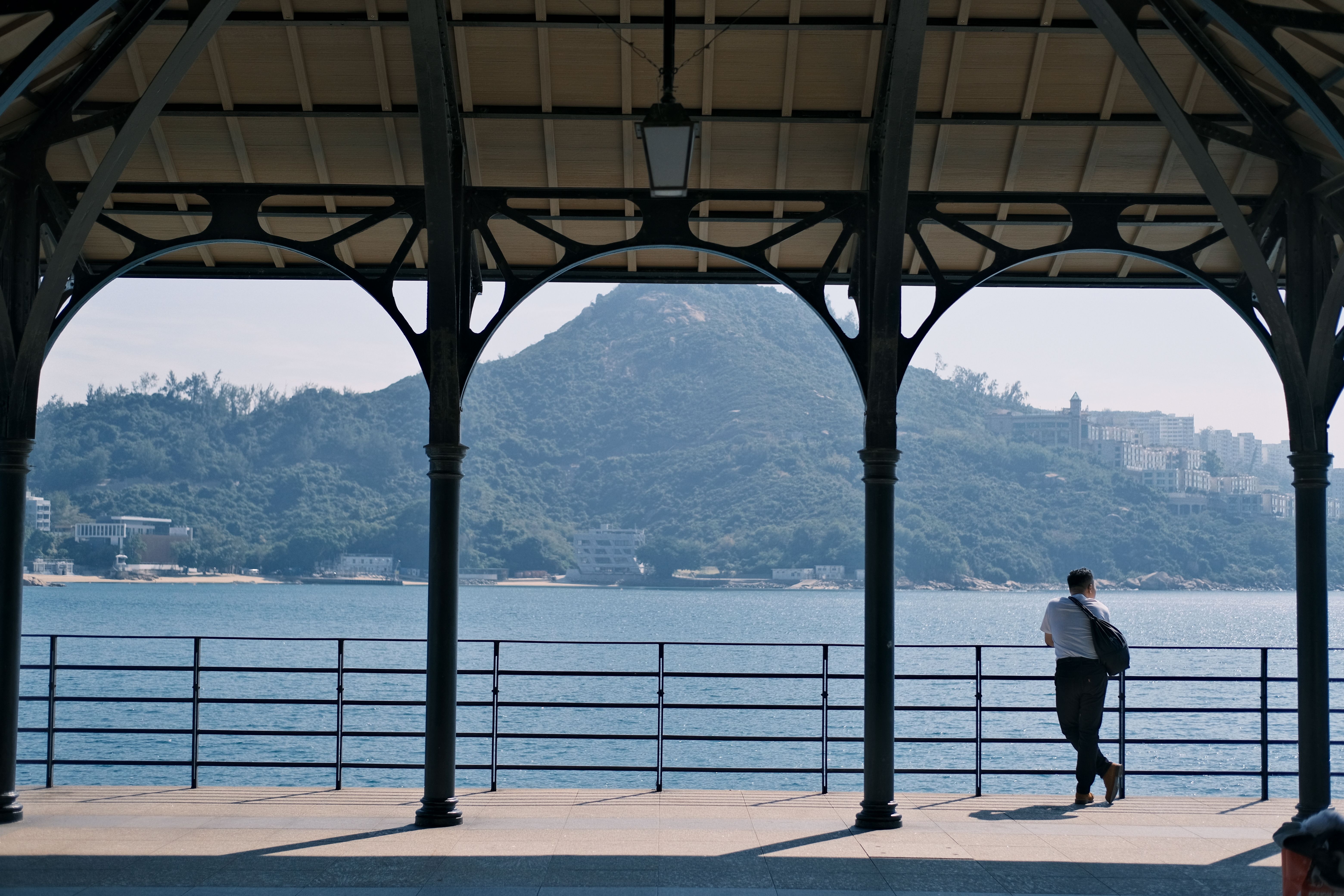 Scenic Waterfront View with Person Standing · Free Stock Photo