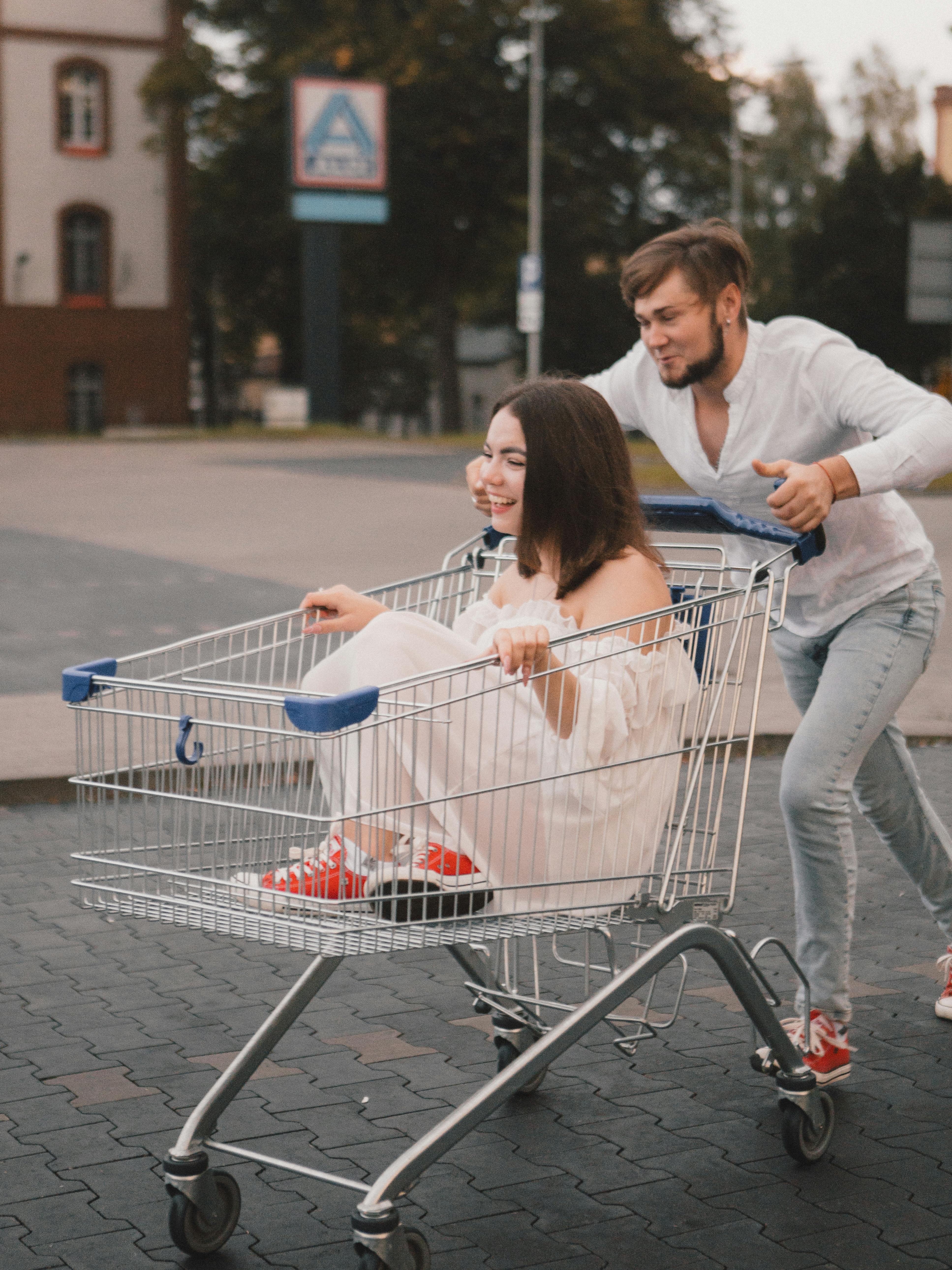 Playful Shopping Cart Ride Outdoors · Free Stock Photo