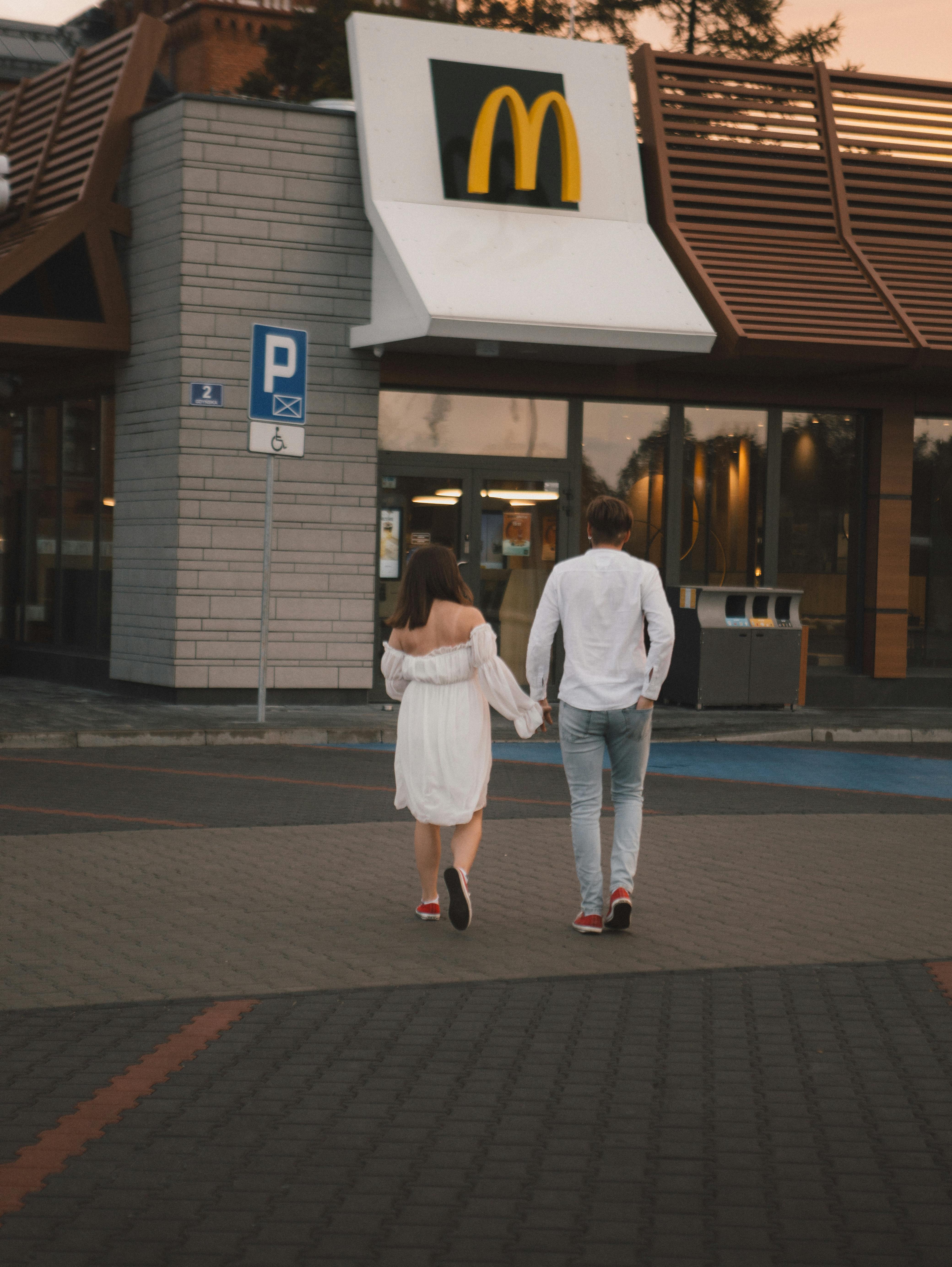 Couple Walking Towards Fast Food Restaurant · Free Stock Photo