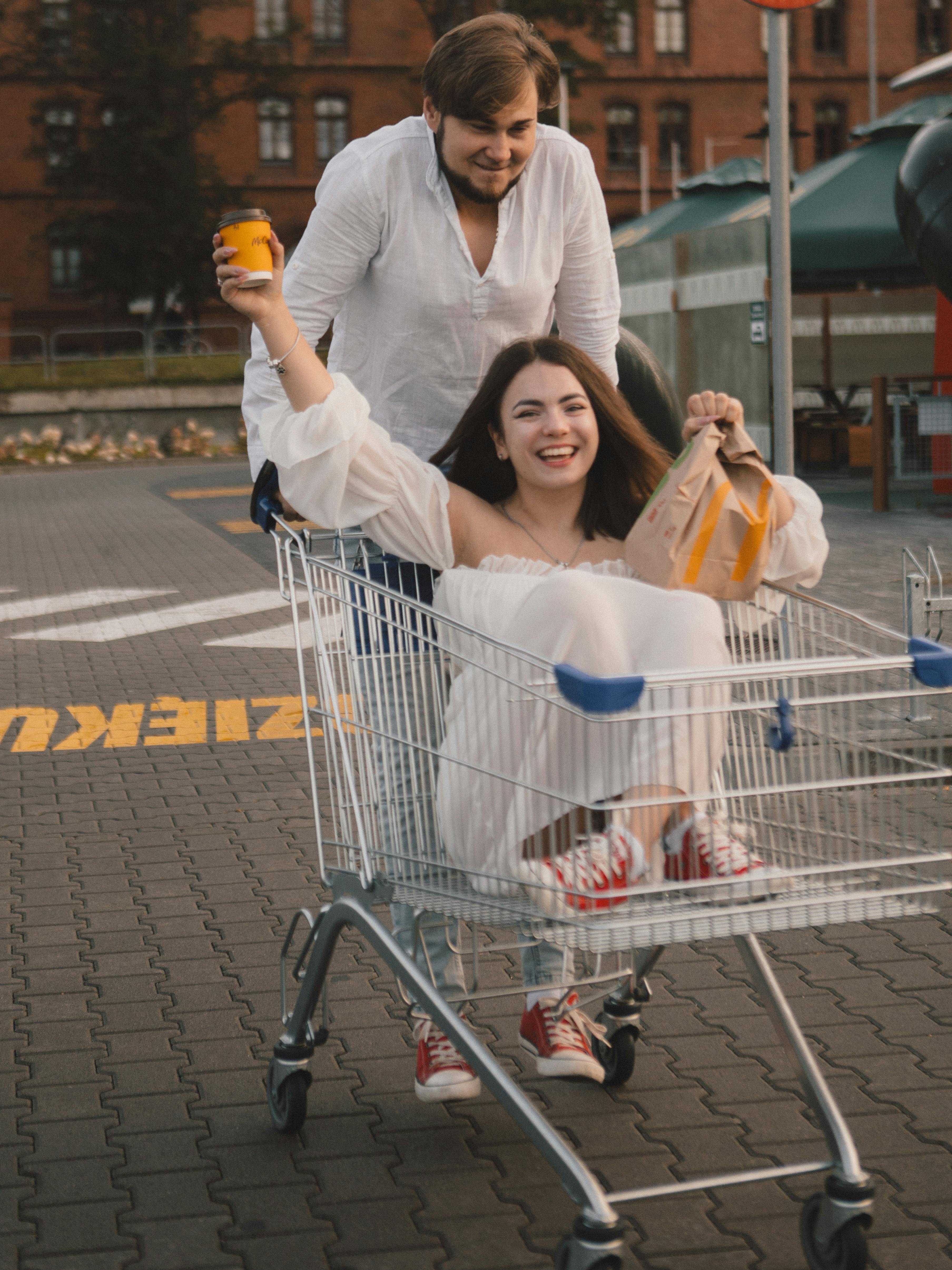 Joyful Shopping Cart Ride Outdoors · Free Stock Photo