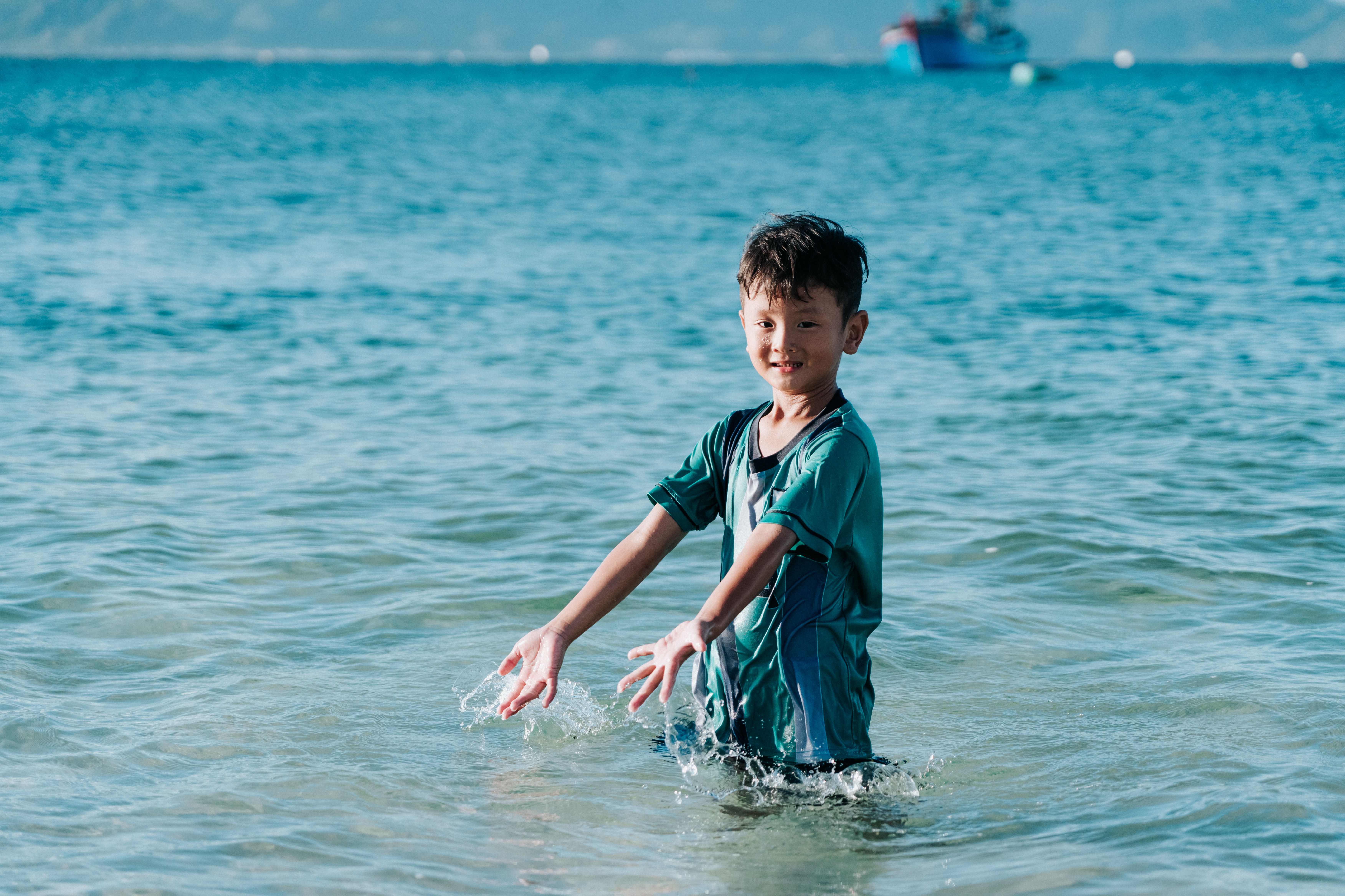 Child Playing Joyfully in Ocean Waves · Free Stock Photo