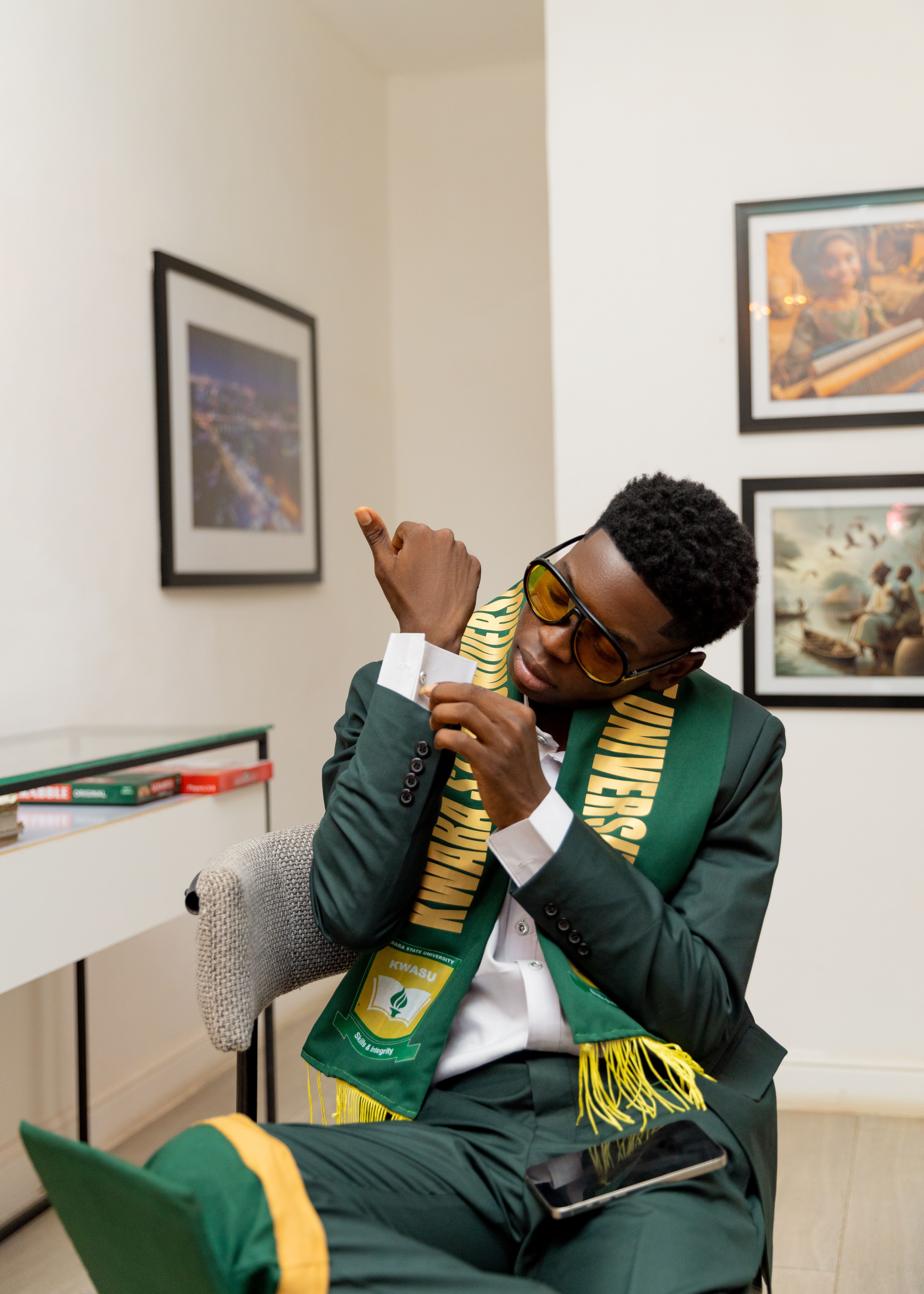 Young Graduate in Green Suit Celebrating Success · Free Stock Photo