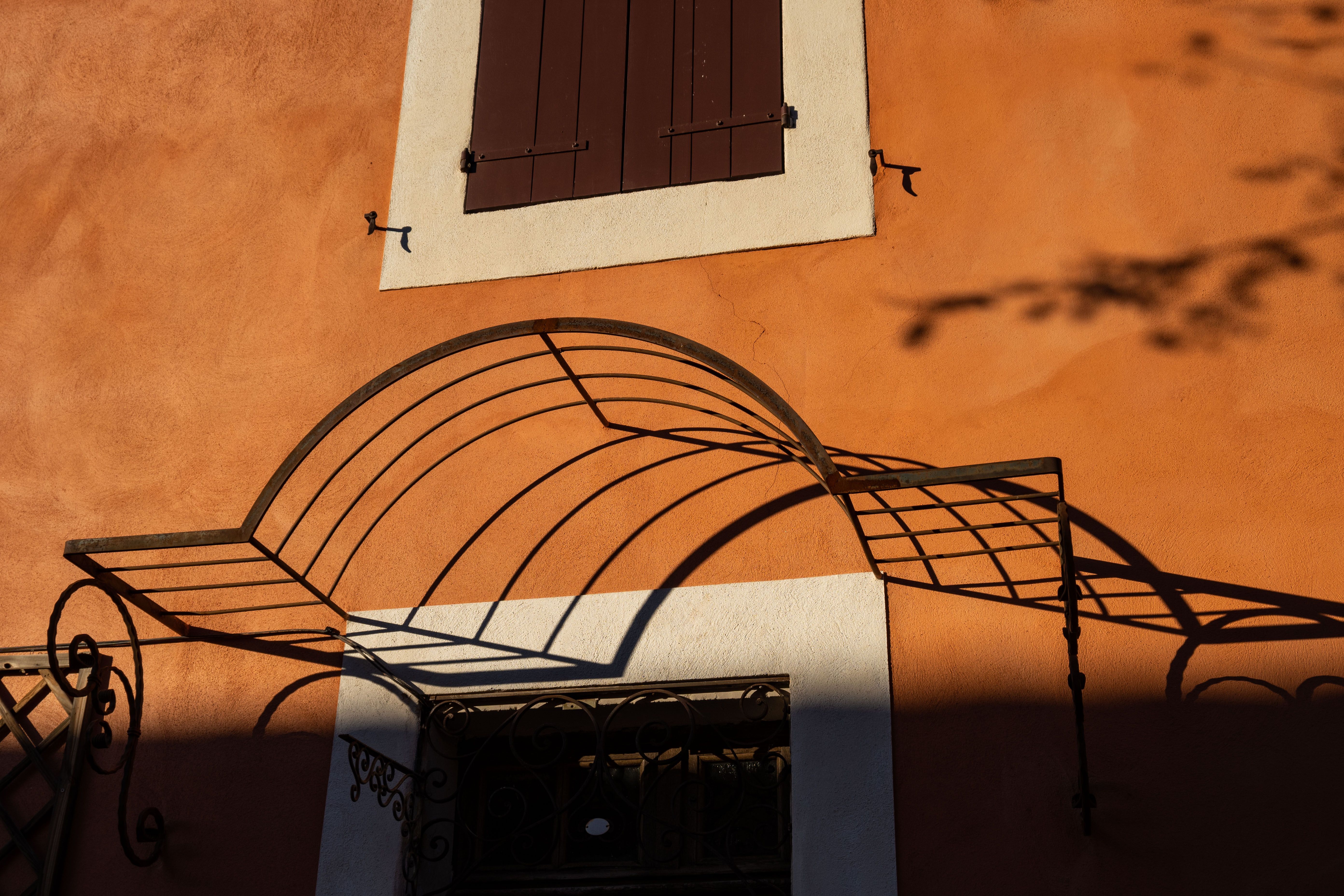 Charming Shadow Play on French Orange Wall · Free Stock Photo