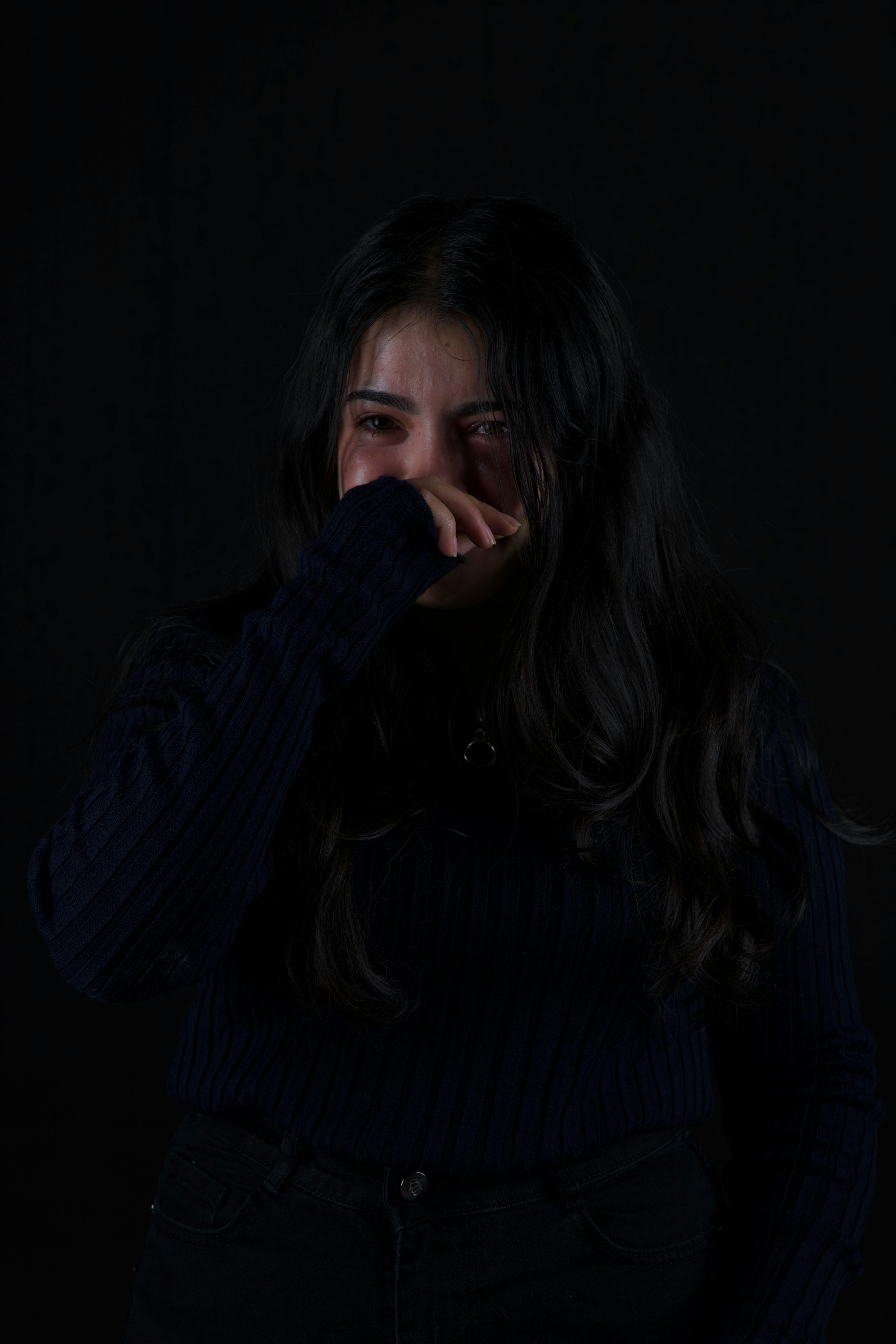 Emotional Portrait of a Woman in Low Light · Free Stock Photo