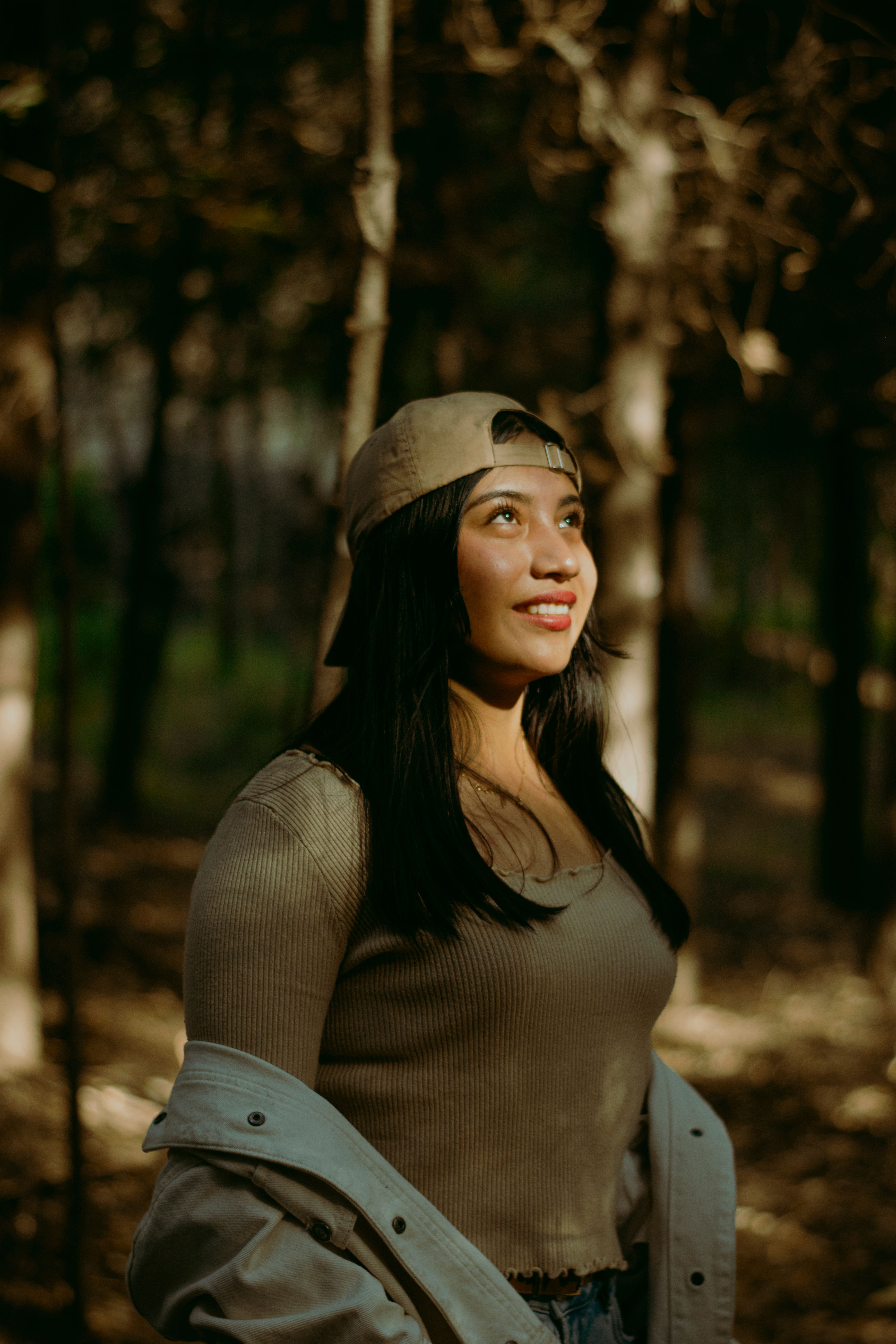 Smiling Woman Enjoying a Day in the Forest · Free Stock Photo