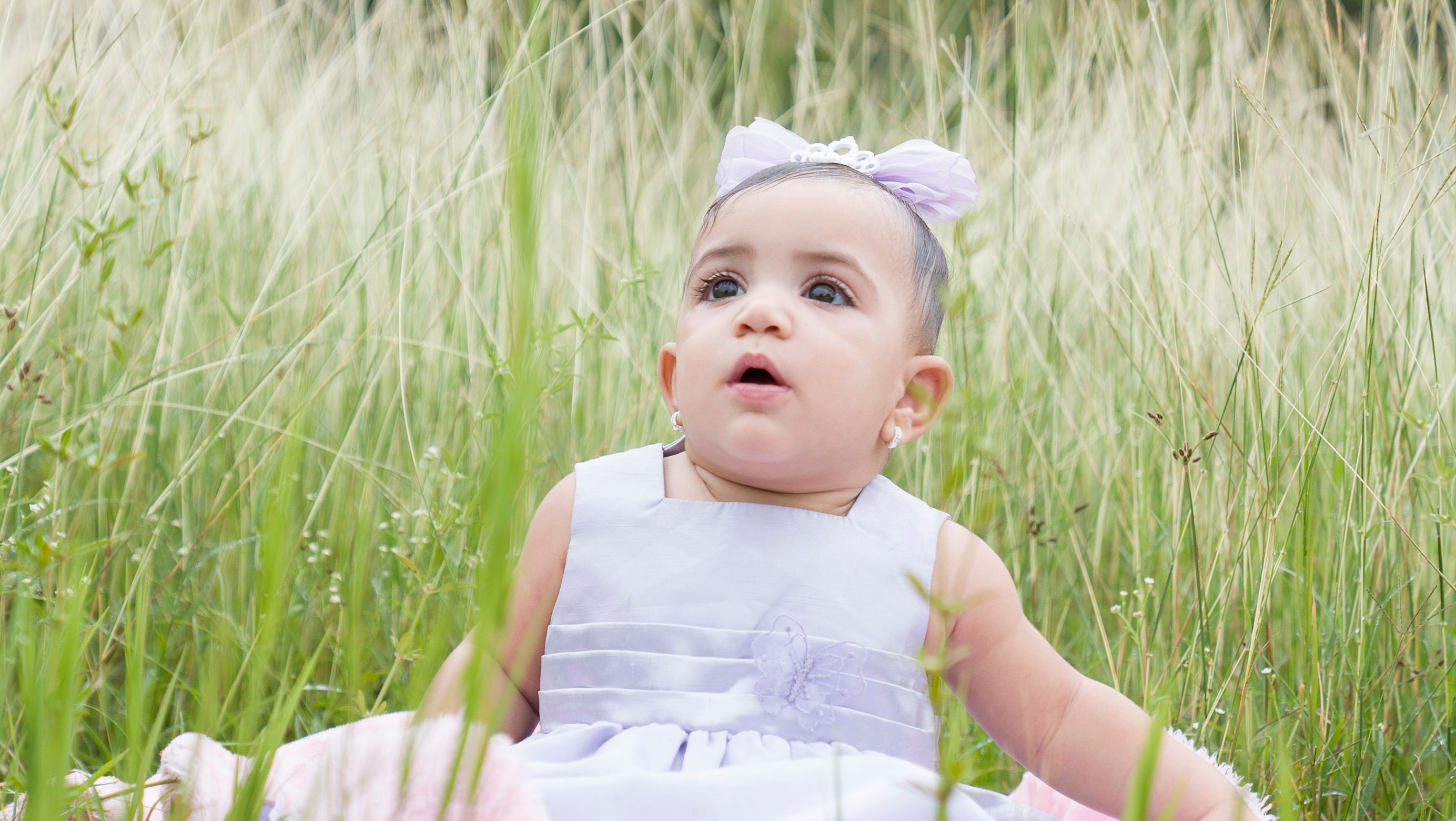 Adorable Baby in Dress with Grass Background · Free Stock Photo