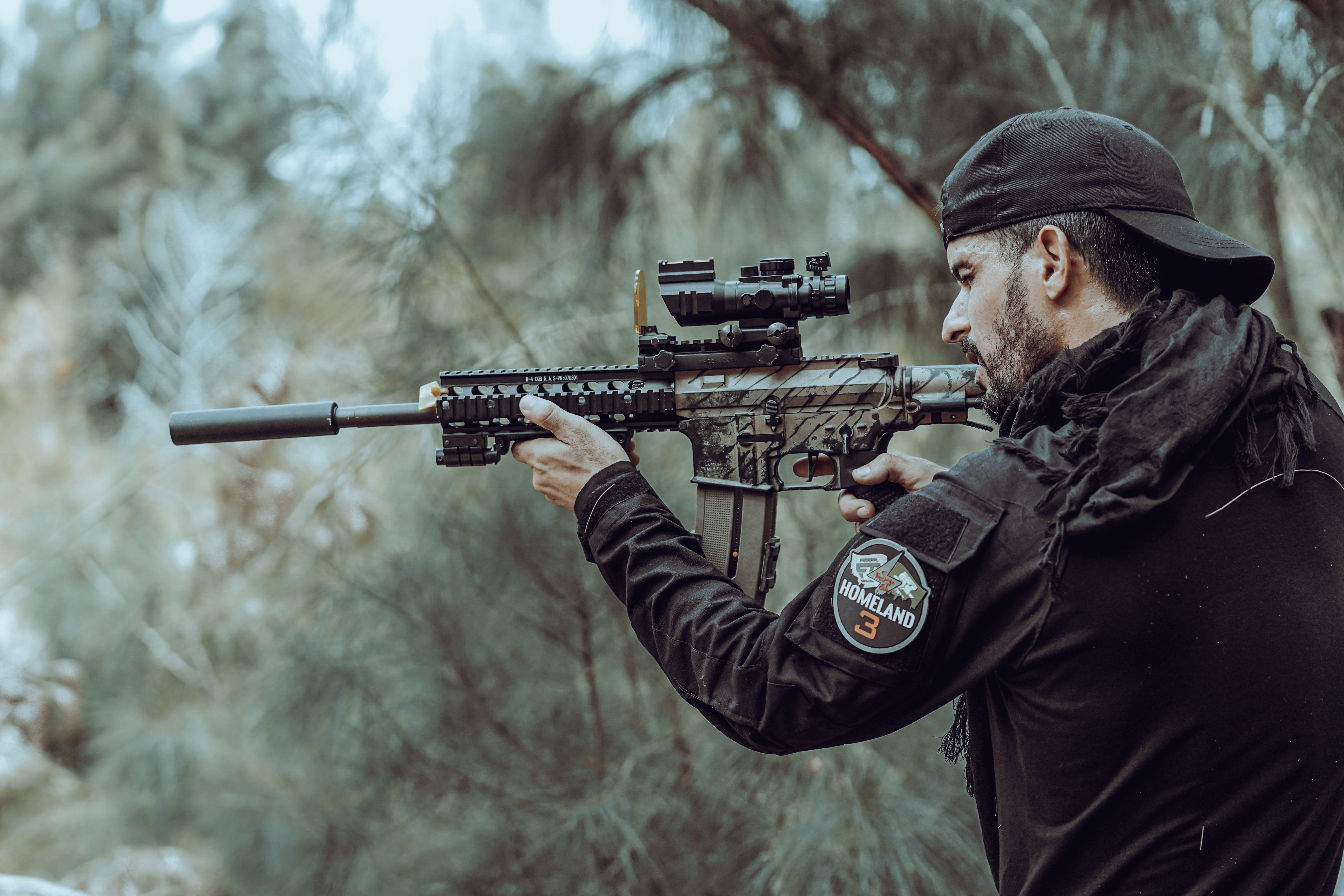 Tactical Marksman Aiming in Outdoor Setting · Free Stock Photo