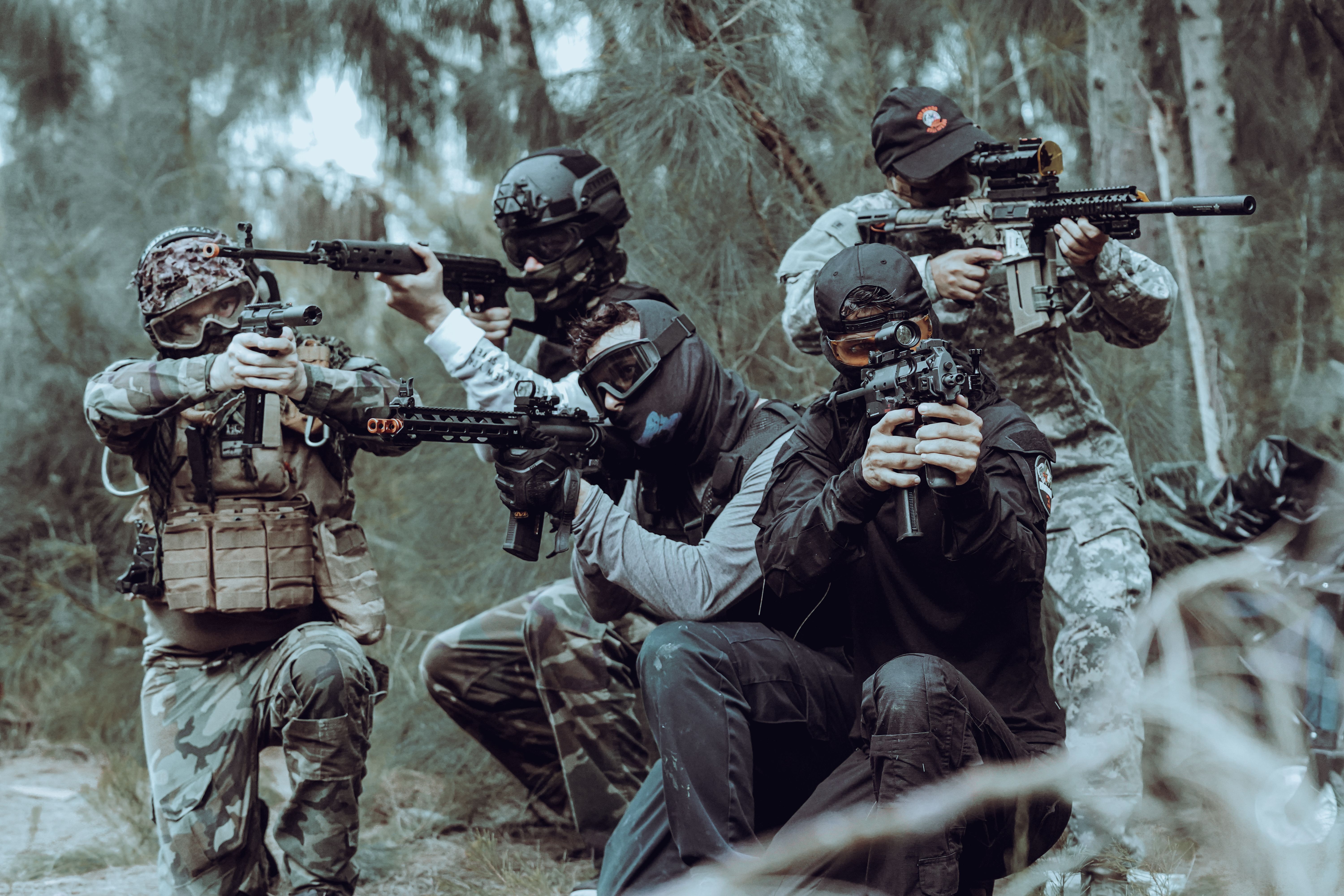 Group of Armed Individuals in Camouflage Outdoors · Free Stock Photo