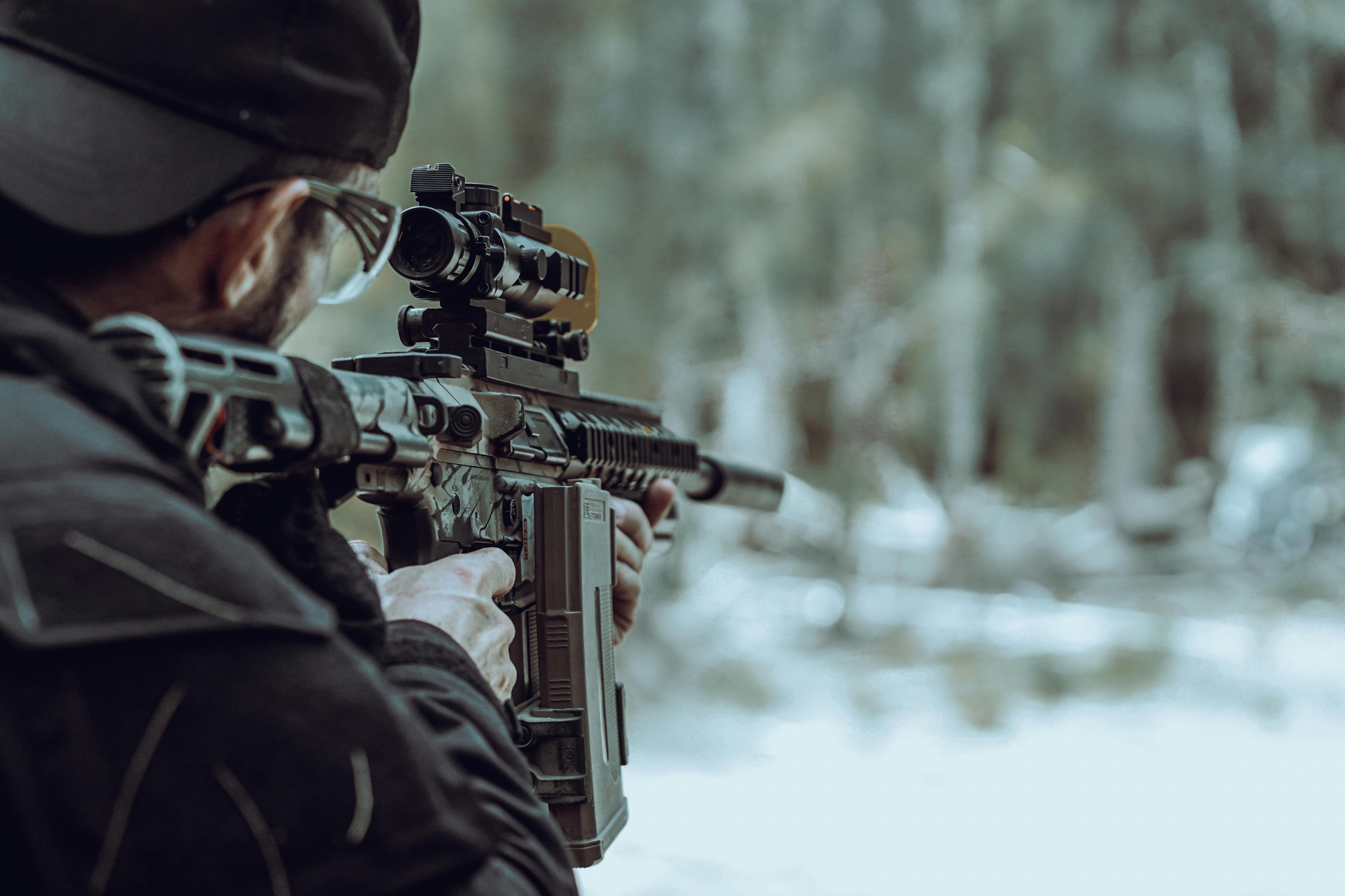 Man Aiming Rifle in Outdoor Shooting Range · Free Stock Photo