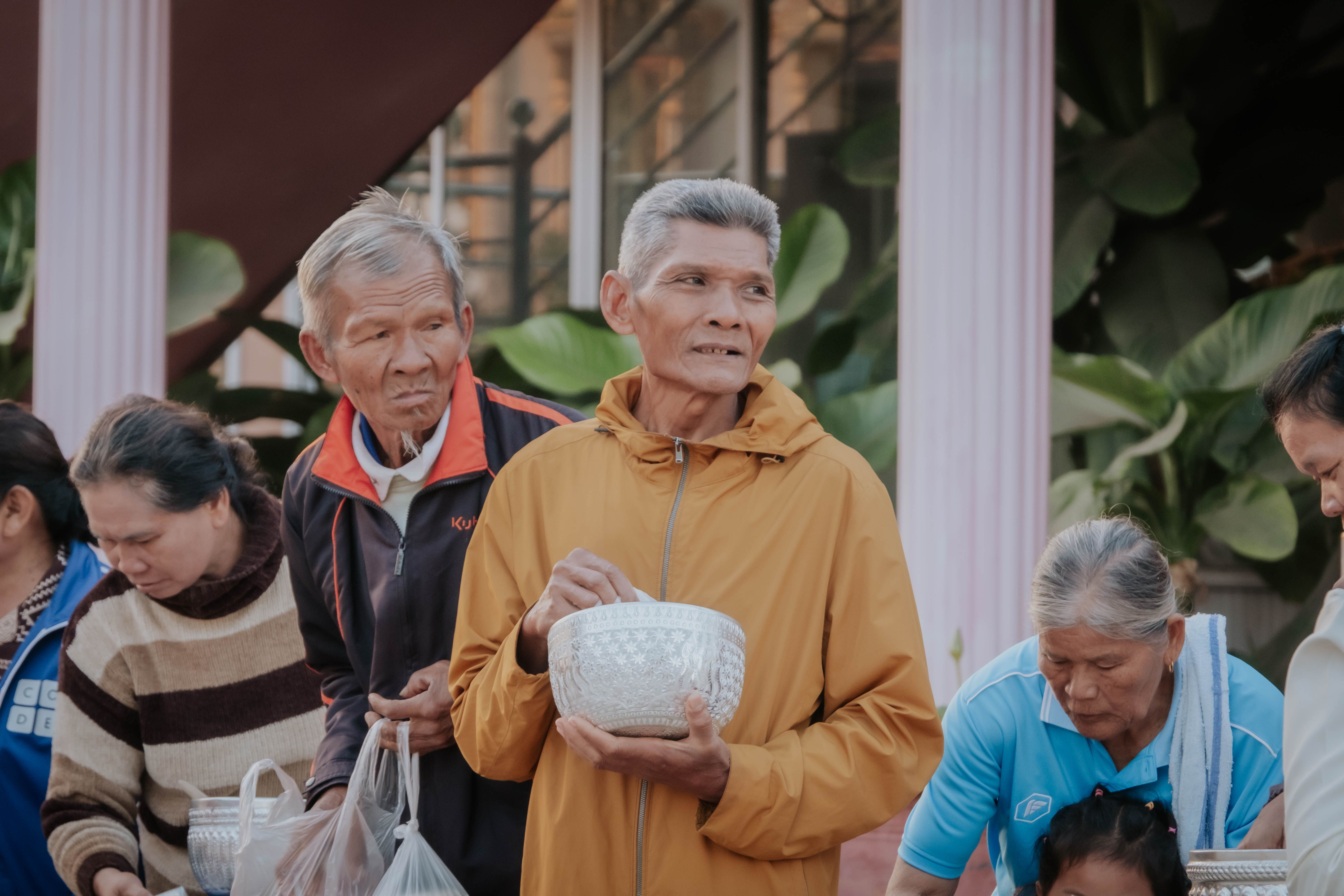 Community Gathering with Elderly Sharing Gifts · Free Stock Photo