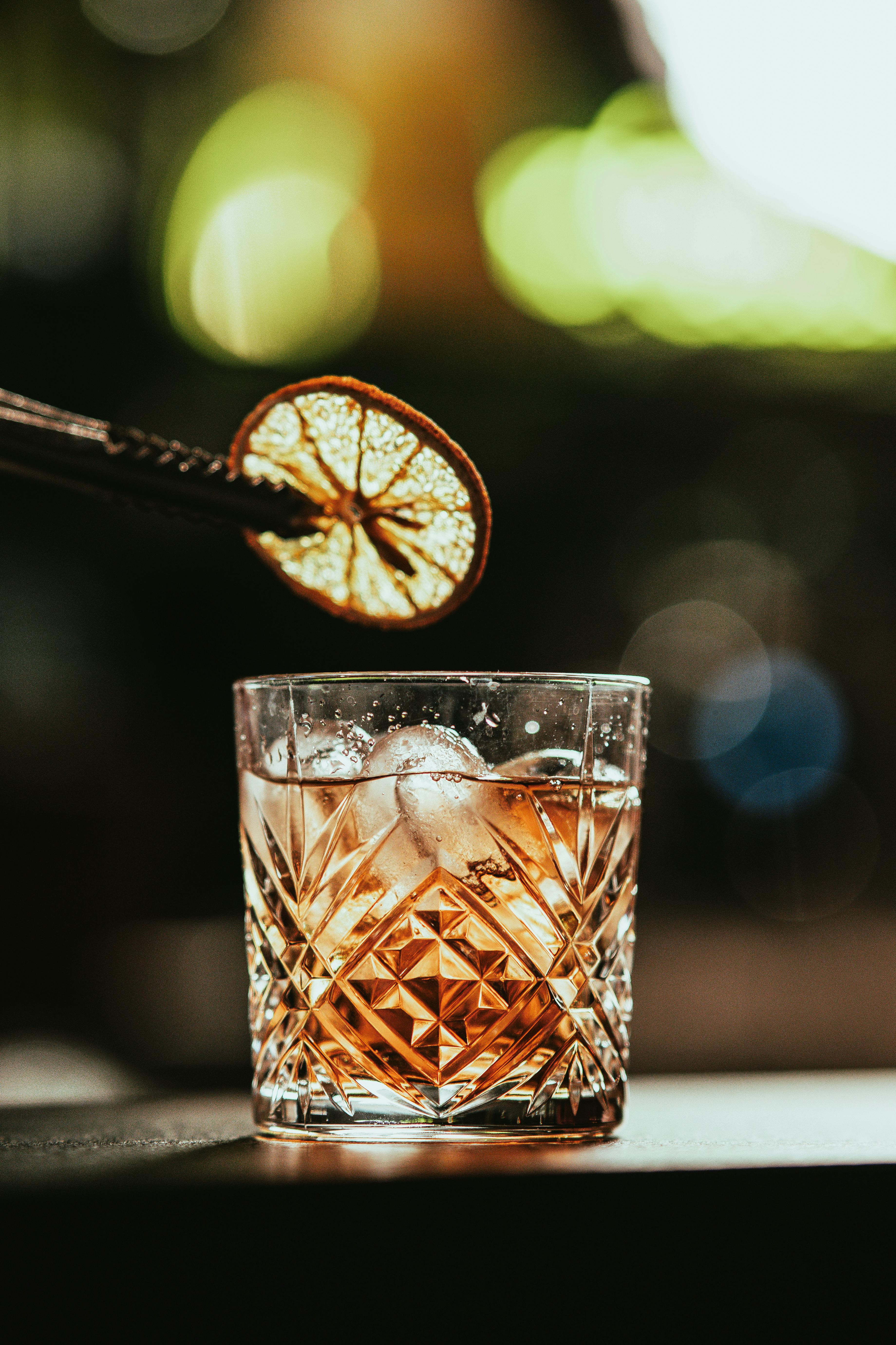 Elegant Cocktail with Citrus Garnish in Crystal Glass · Free Stock Photo