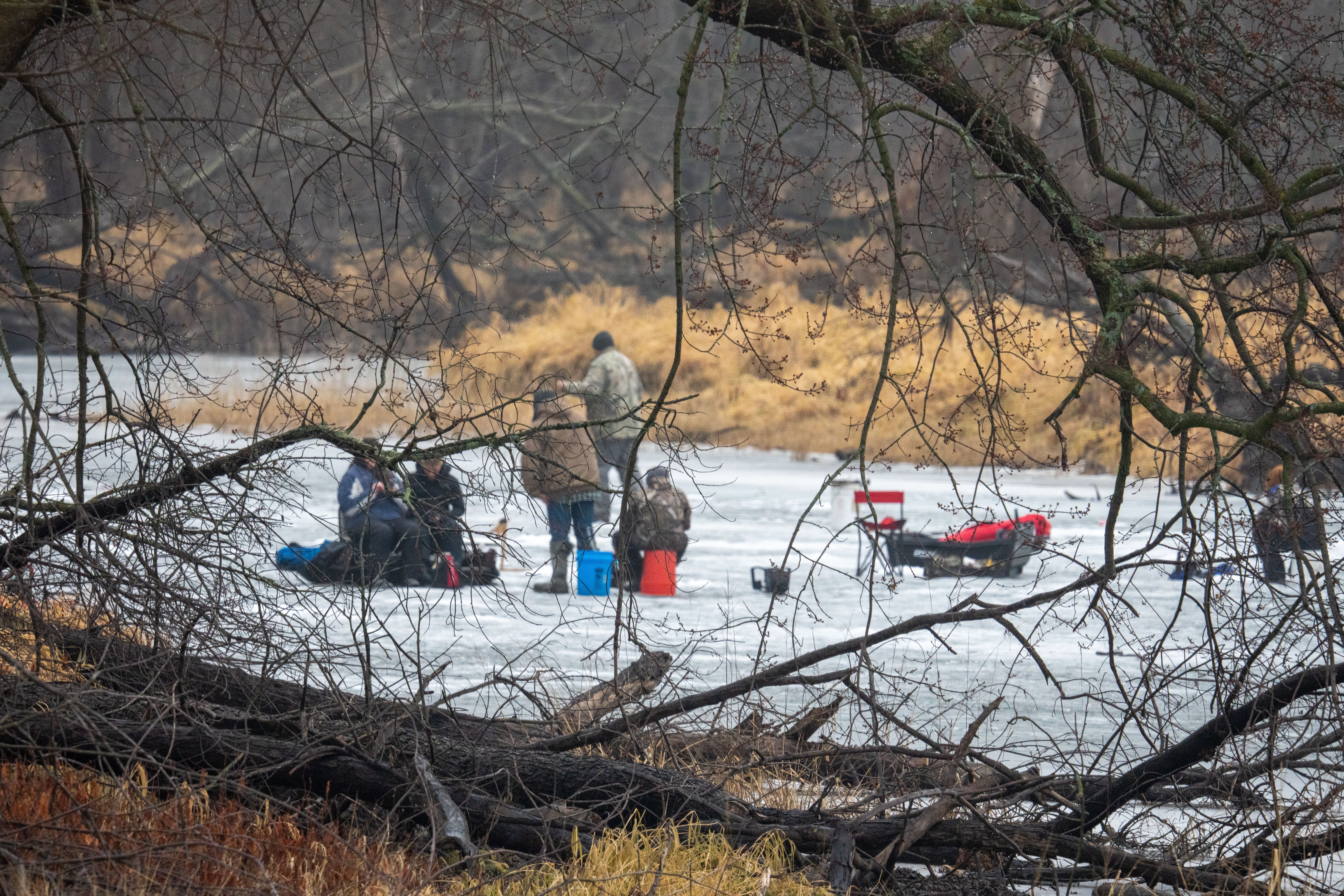 Ice Fishing on Frozen Lake in Winter · Free Stock Photo