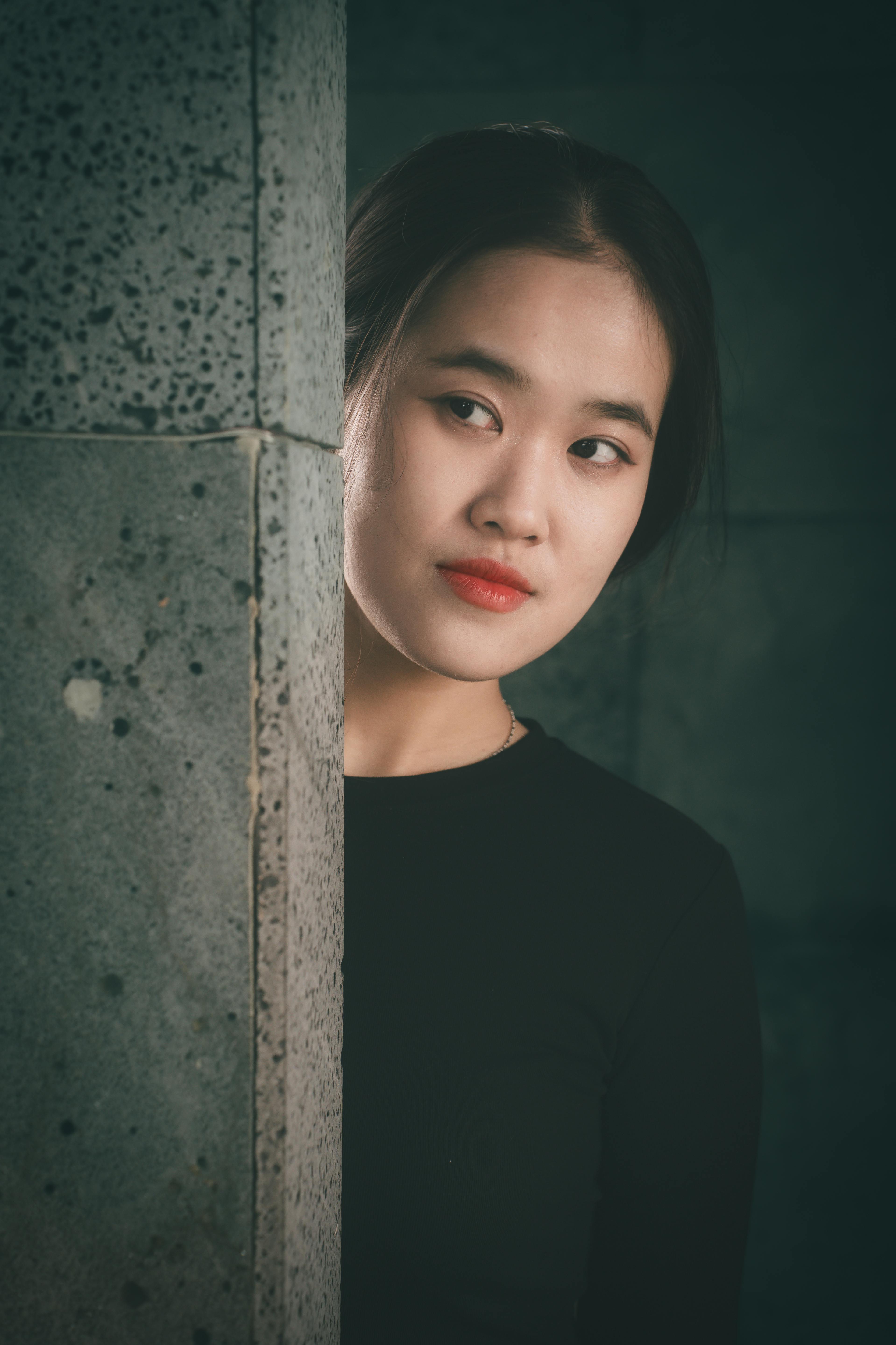 Intriguing Portrait of Woman in Dark Setting · Free Stock Photo