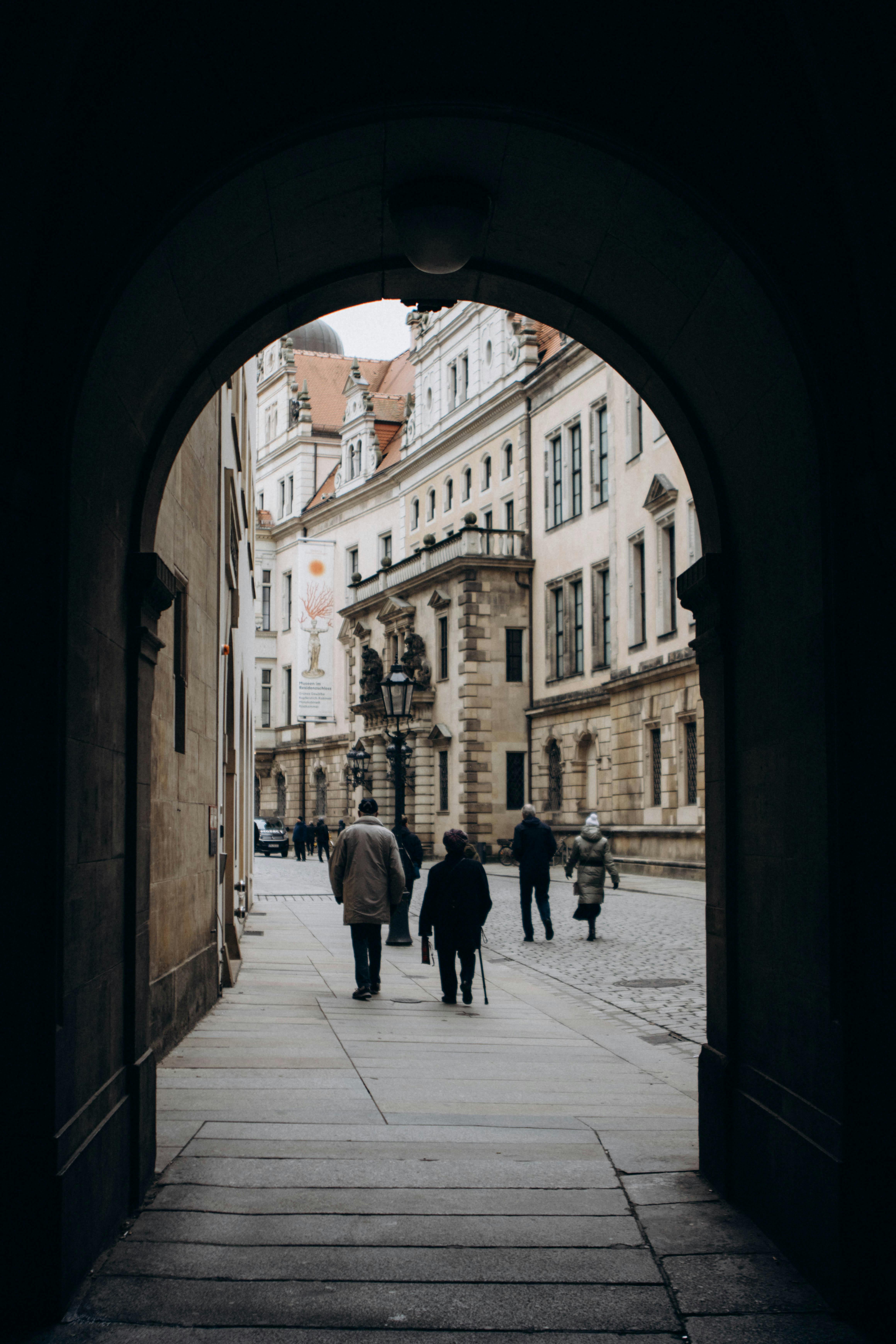 Historic European City Street with Archway View · Free Stock Photo