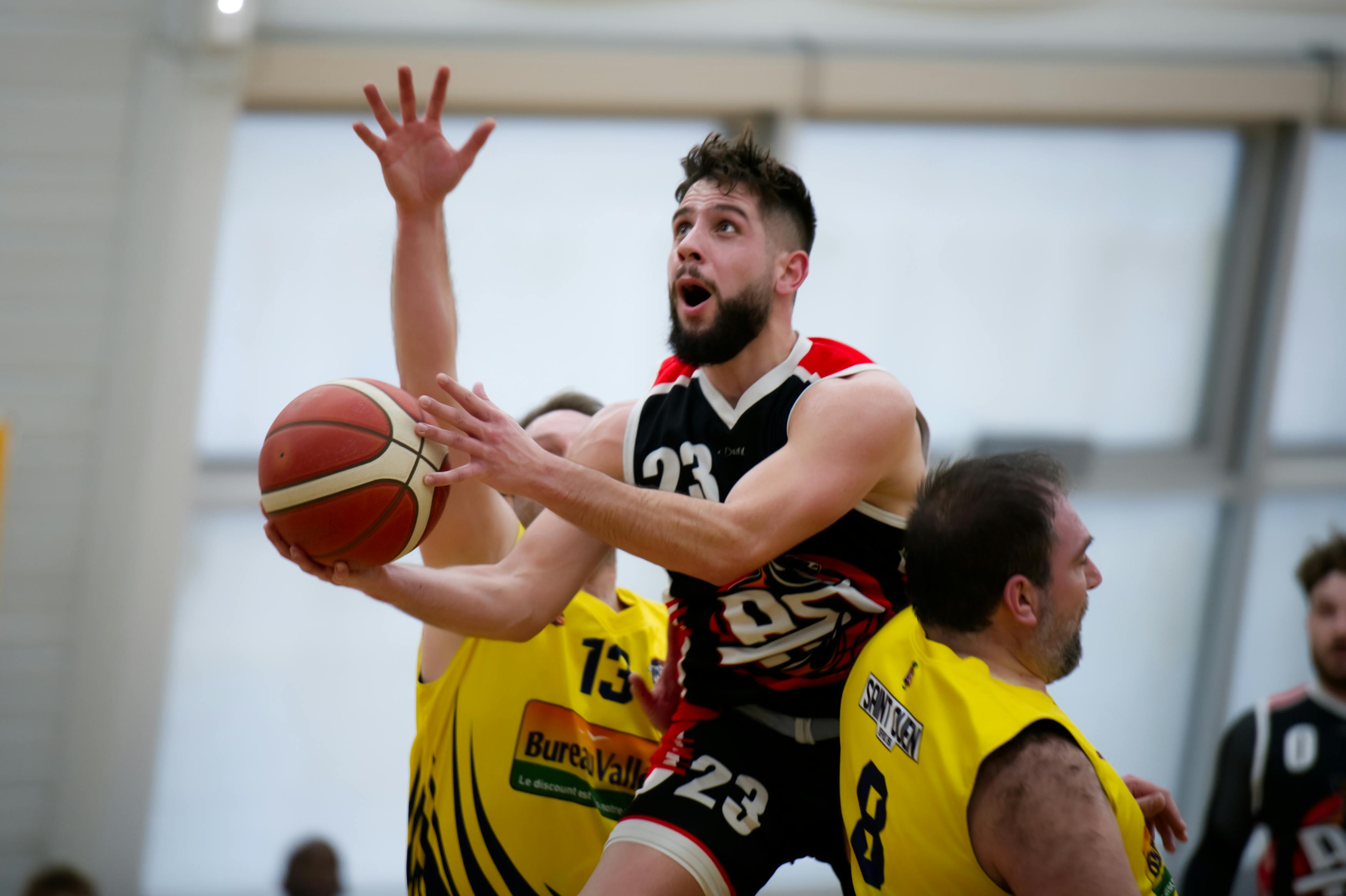 Intense Basketball Game Action Shot Indoors · Free Stock Photo
