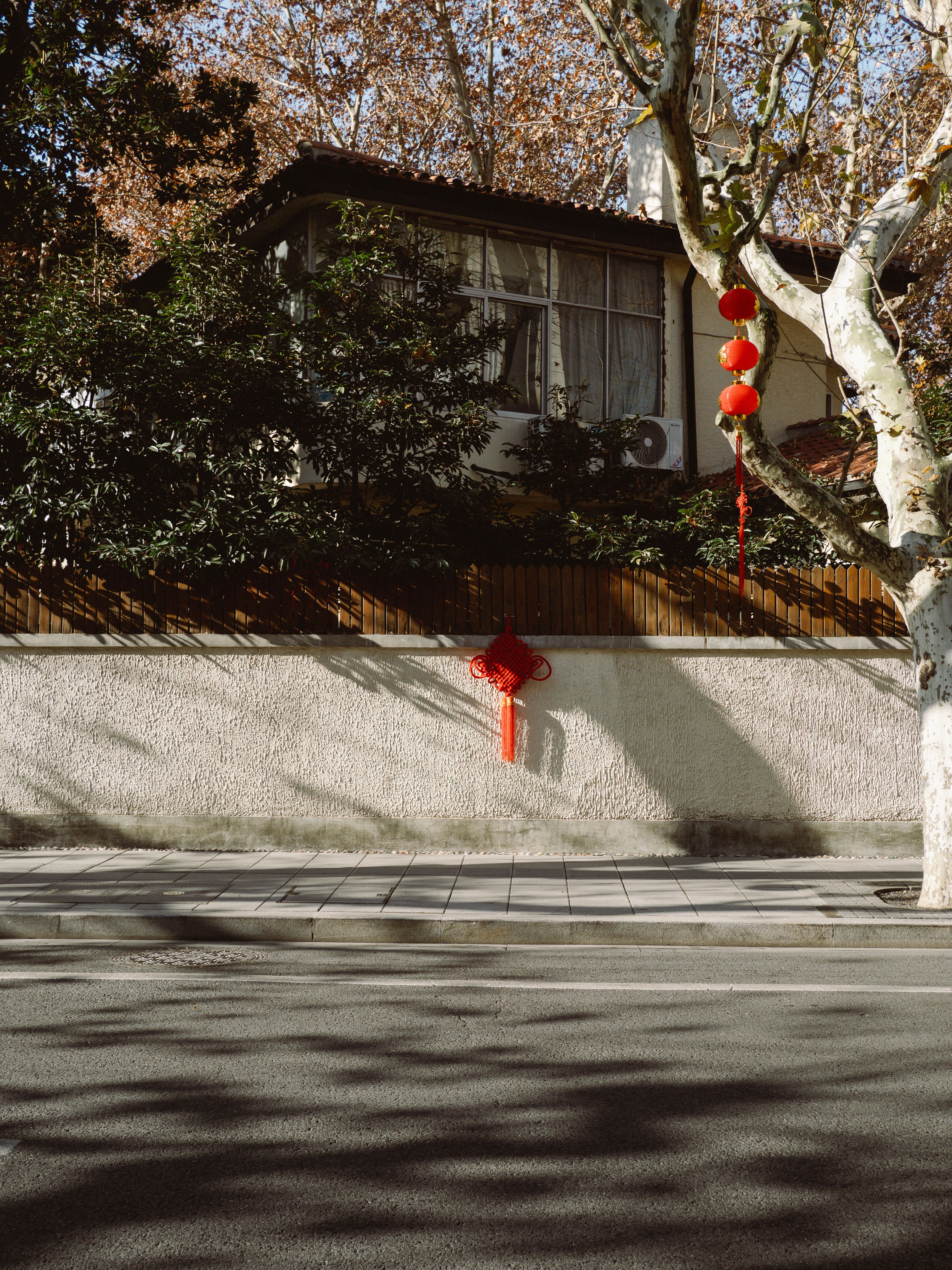 House with Red Lanterns in Sunny Urban Setting · Free Stock Photo